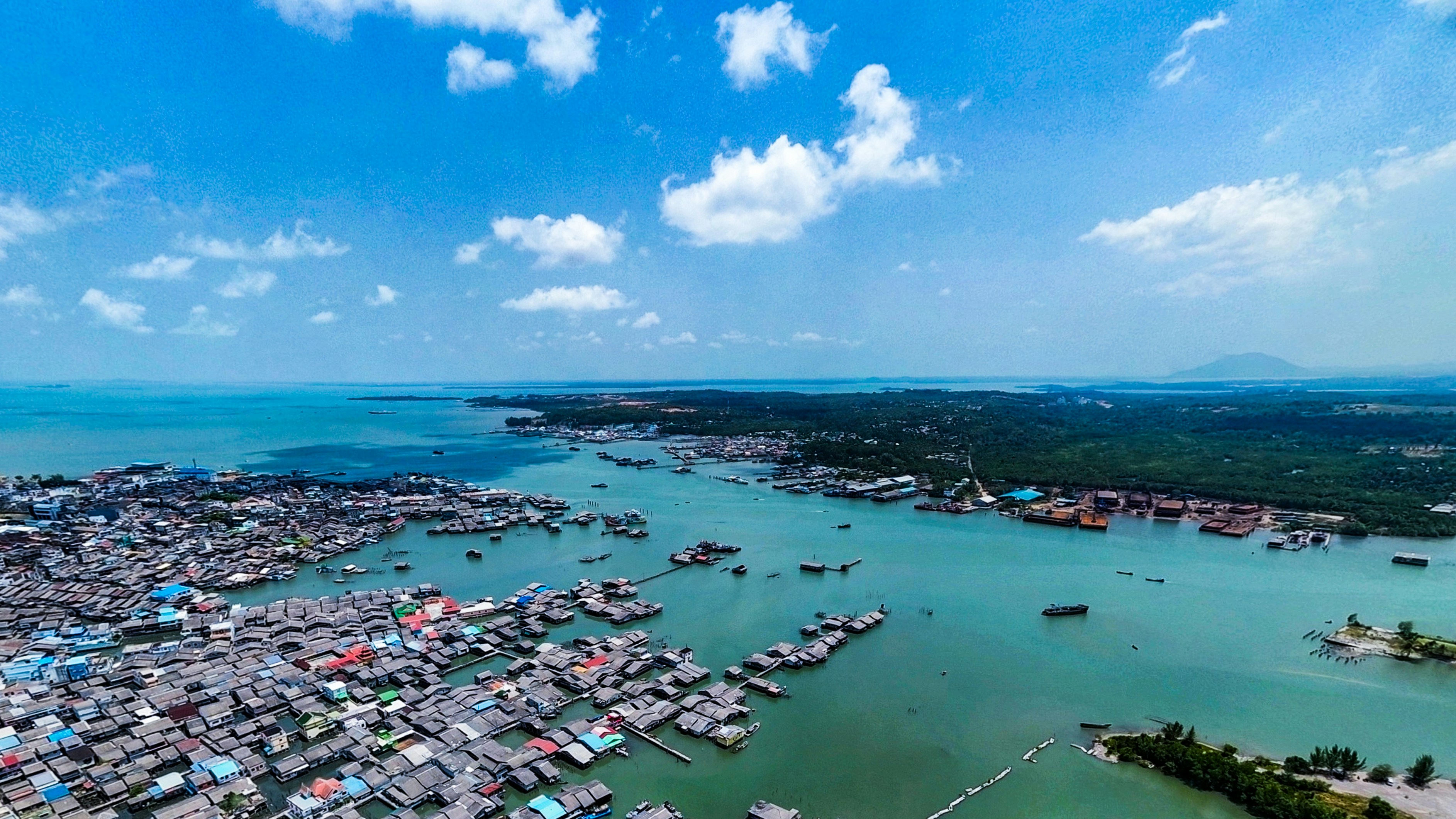 Azure Harbor: Aerial Tapestry of Colorful Docks and Coral Waters