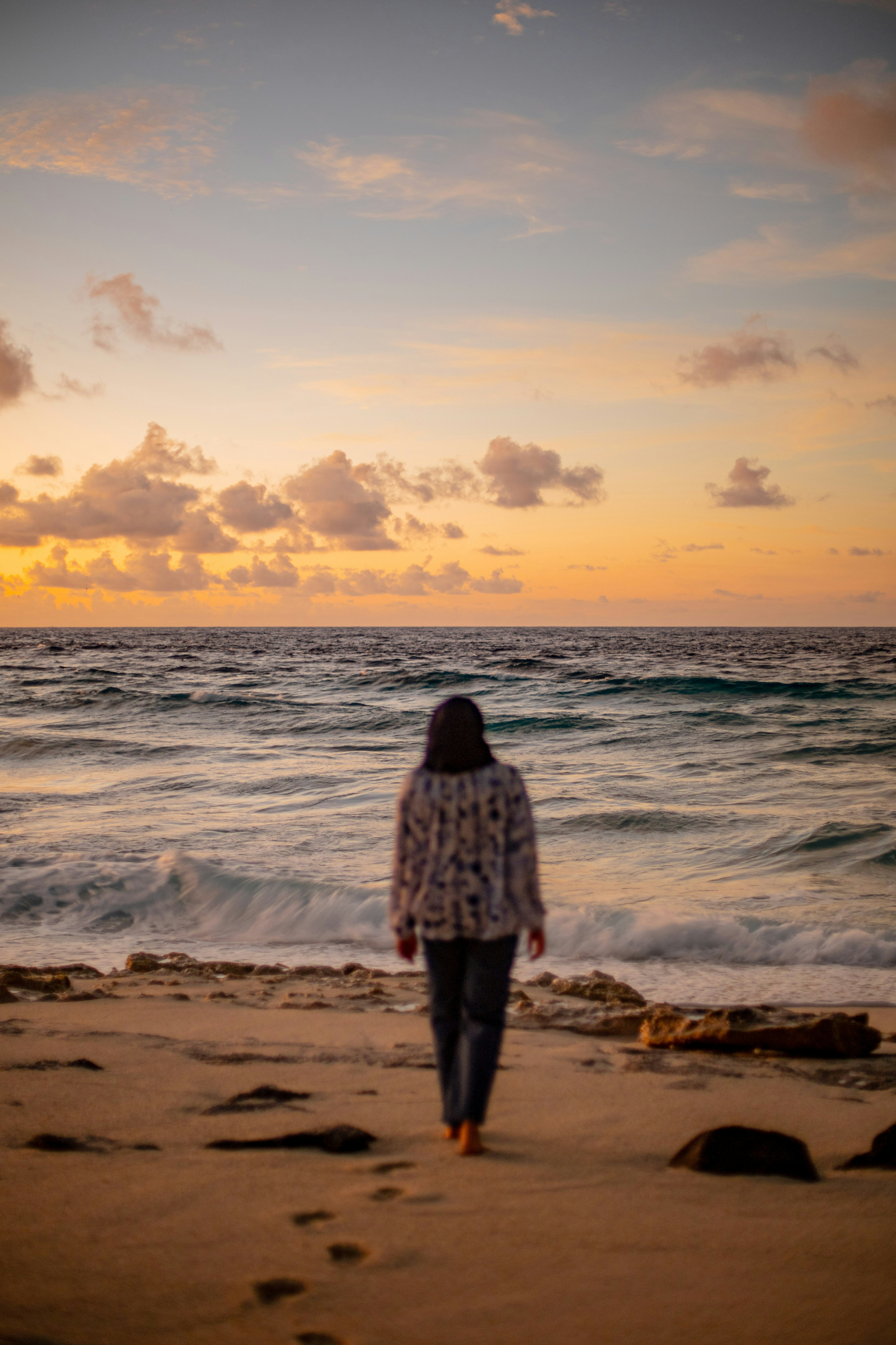 Horizon Quiet: A Figure at the Sea's Edge at Sunset