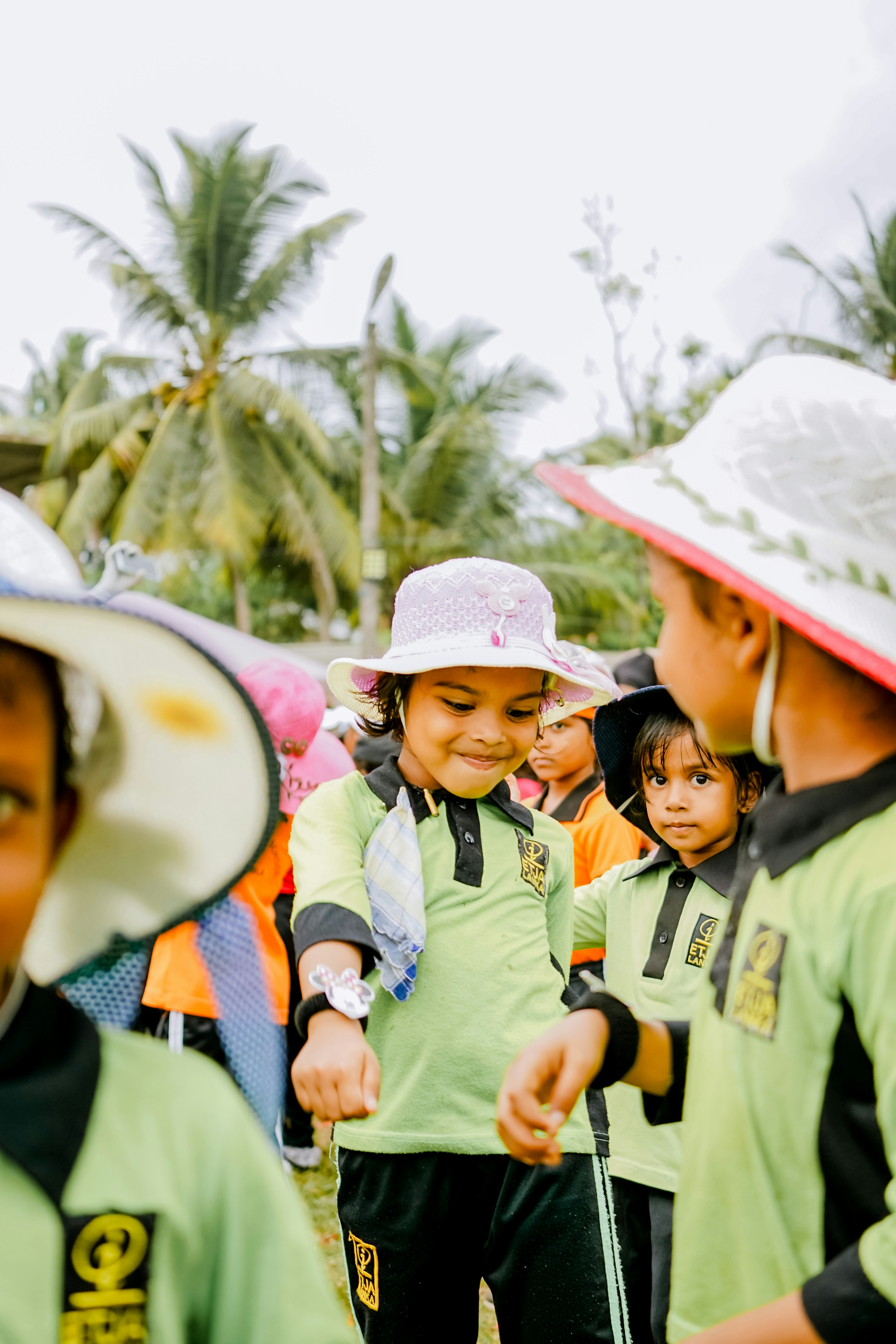 Childhood Carnival: A Moment of Shared Glee Under Bright Hats