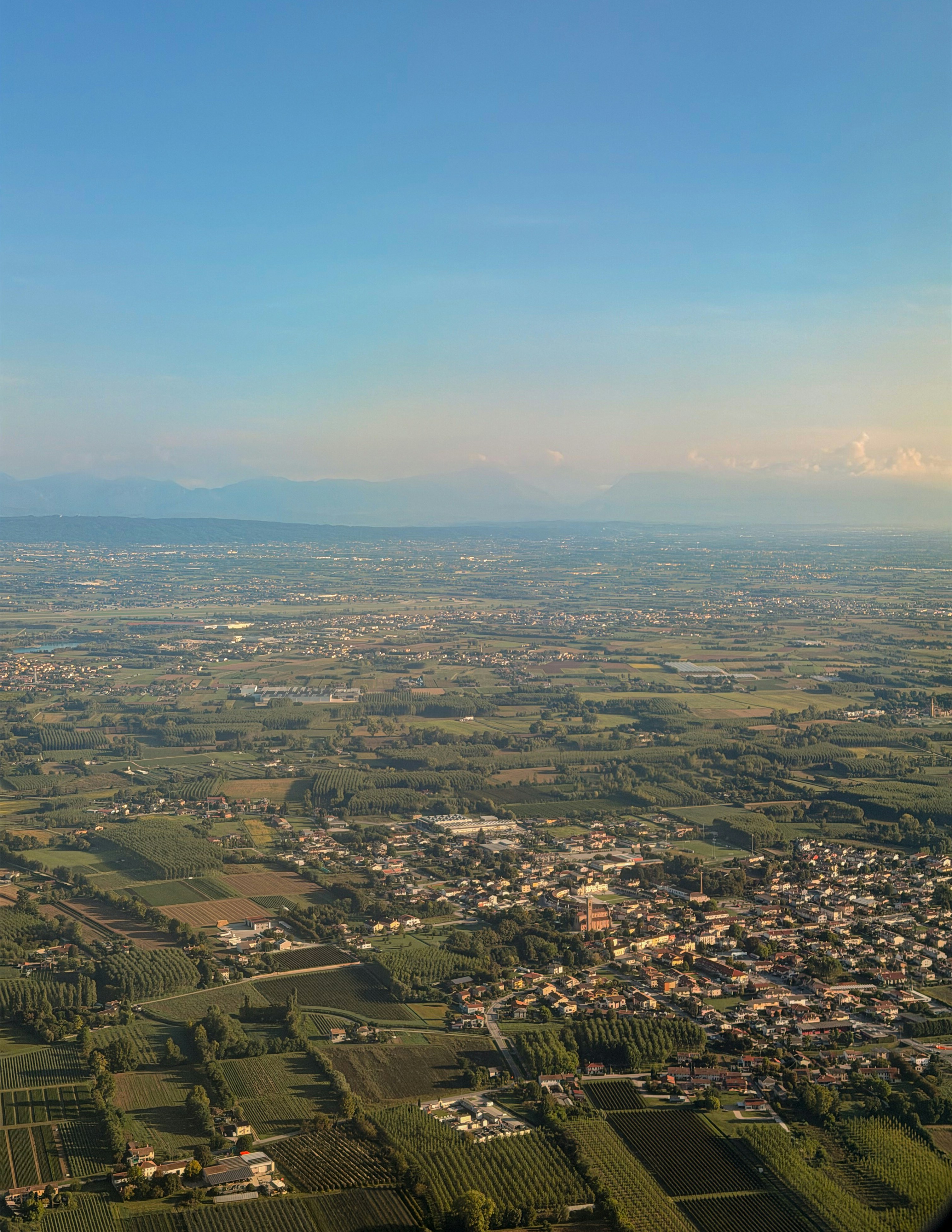 Aerial Quilt: Verdant Fields Stretching Toward a Distant Horizon