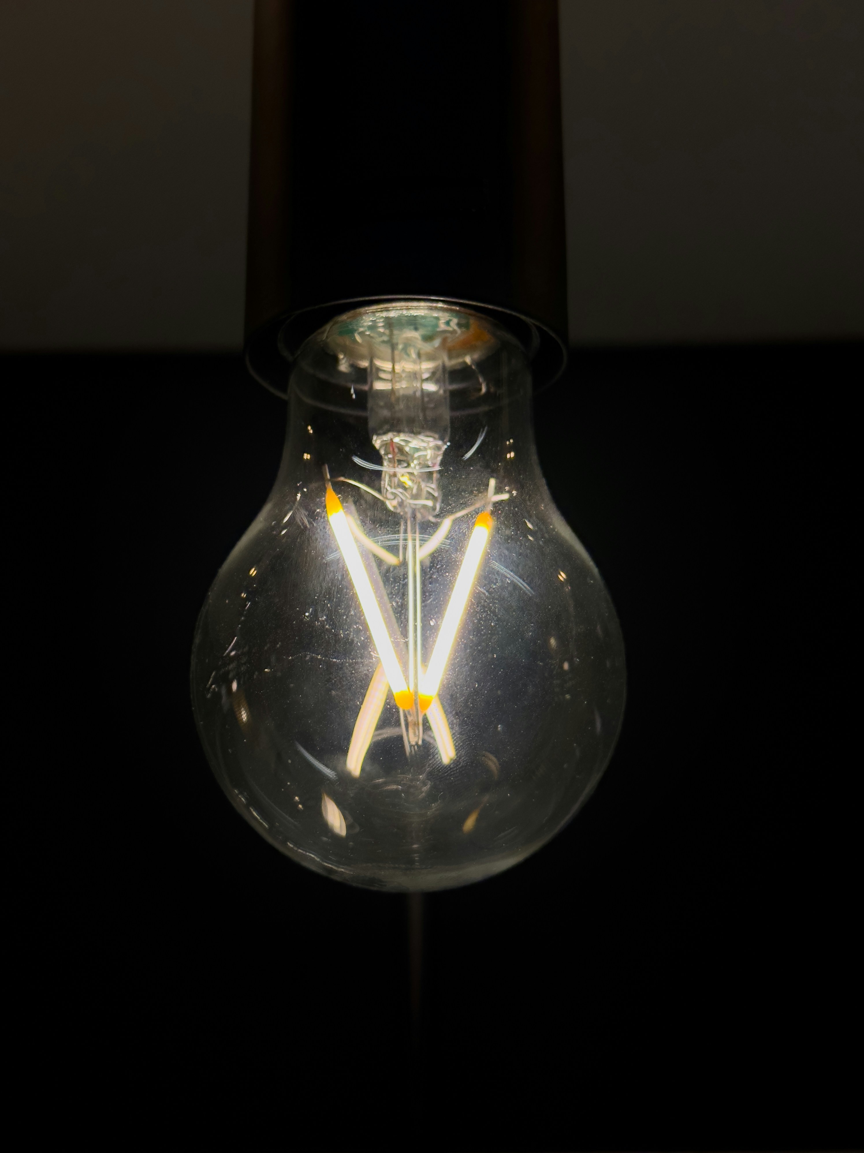 Glowing Filament in a Quiet Night: A Minimalist Bulb Portrait