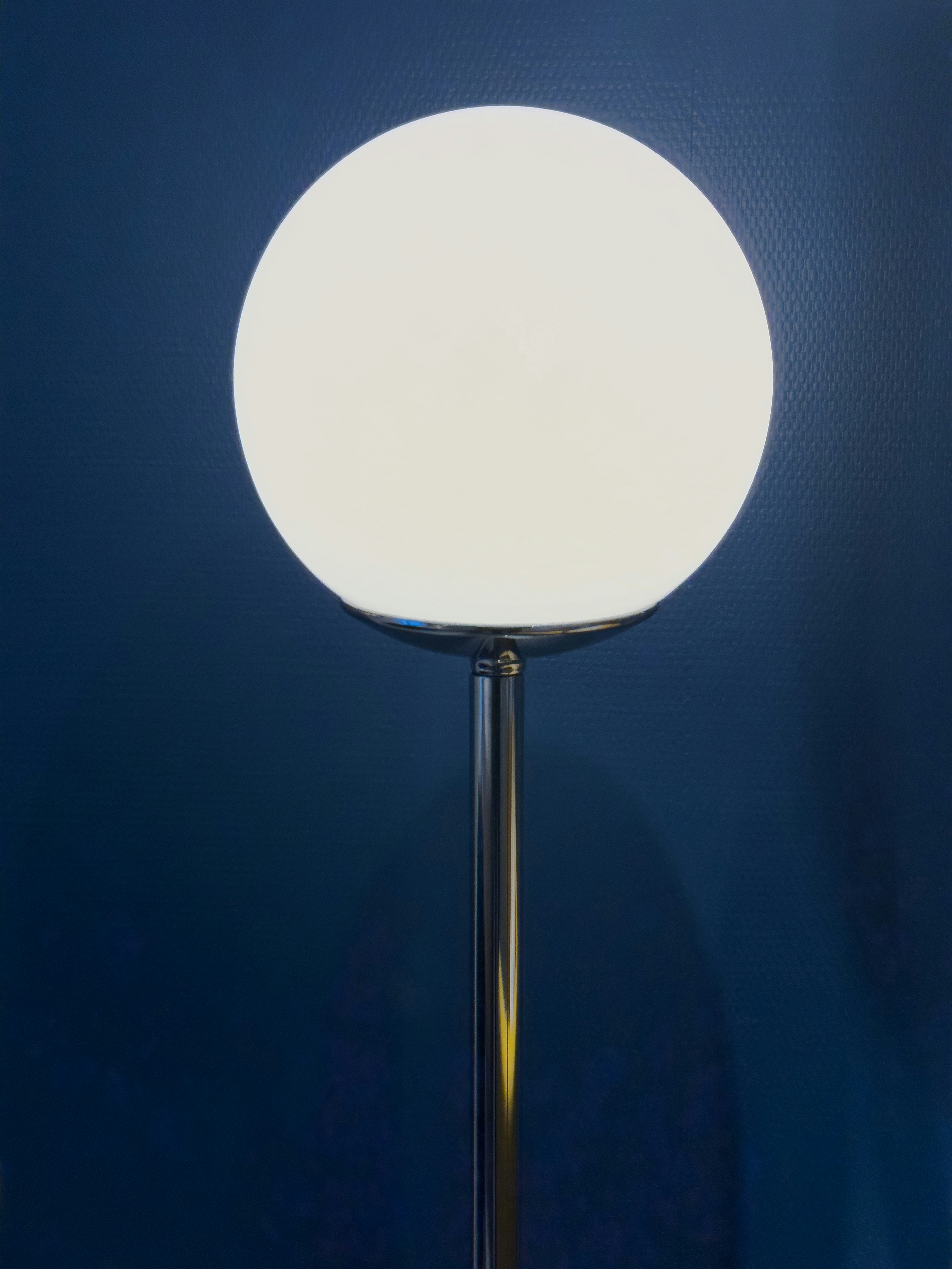 Glowing Globe on a Mirror Pedestal