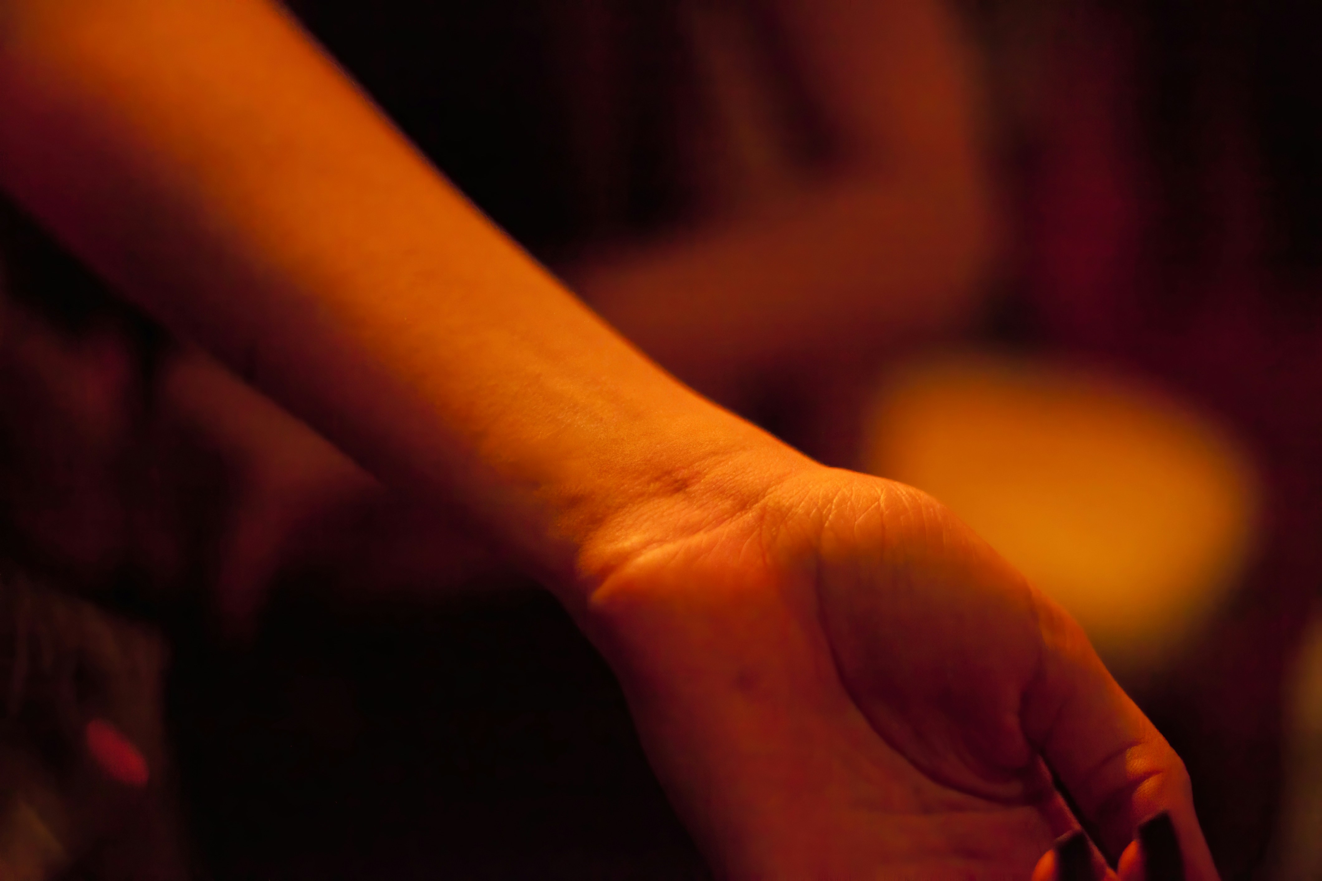 Warm Handreach: A Softly Lit Gesture in Velvet Darkness