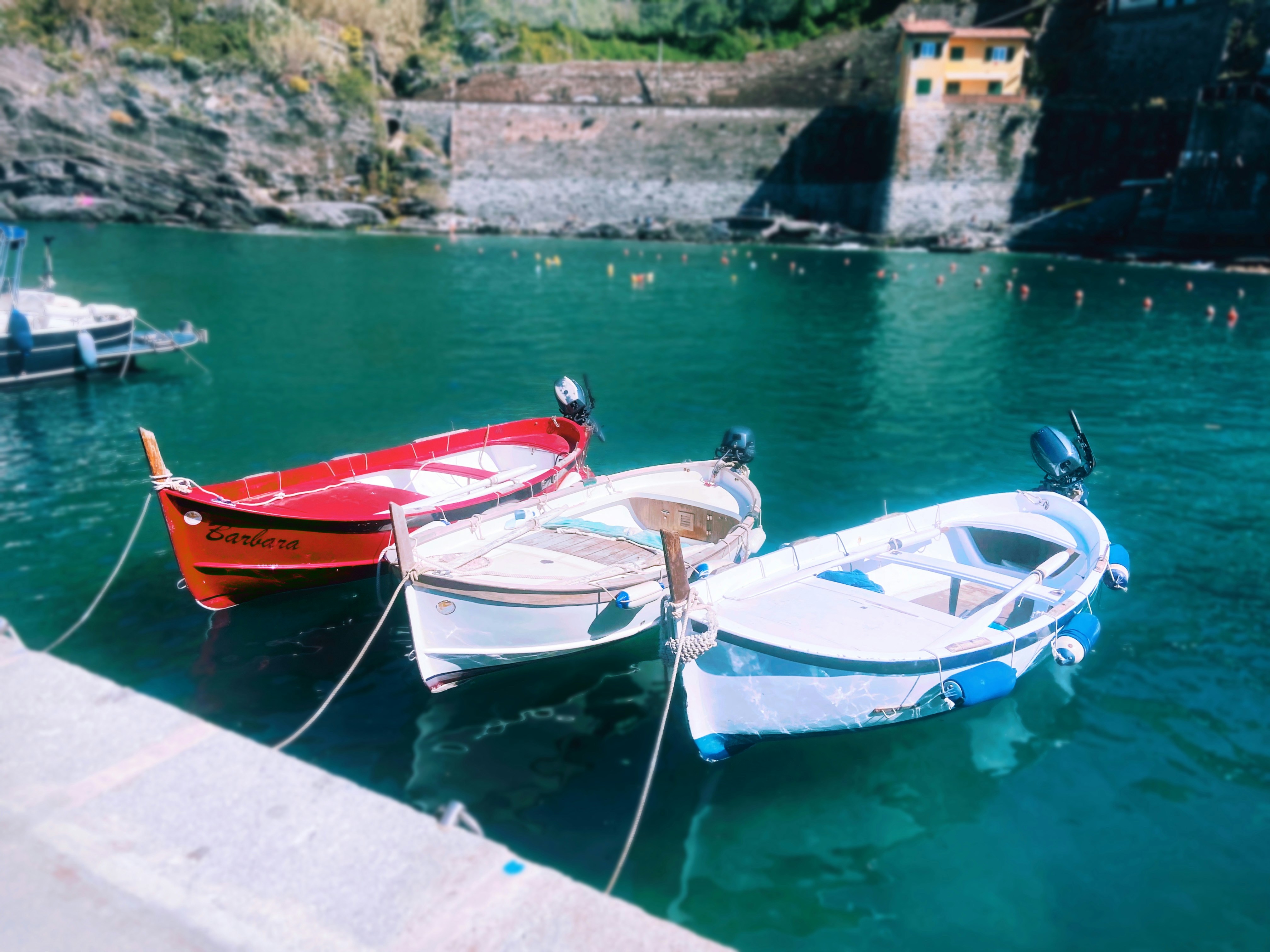 Three Boats in Turquoise Harbor: A Quiet Dockyard Morning