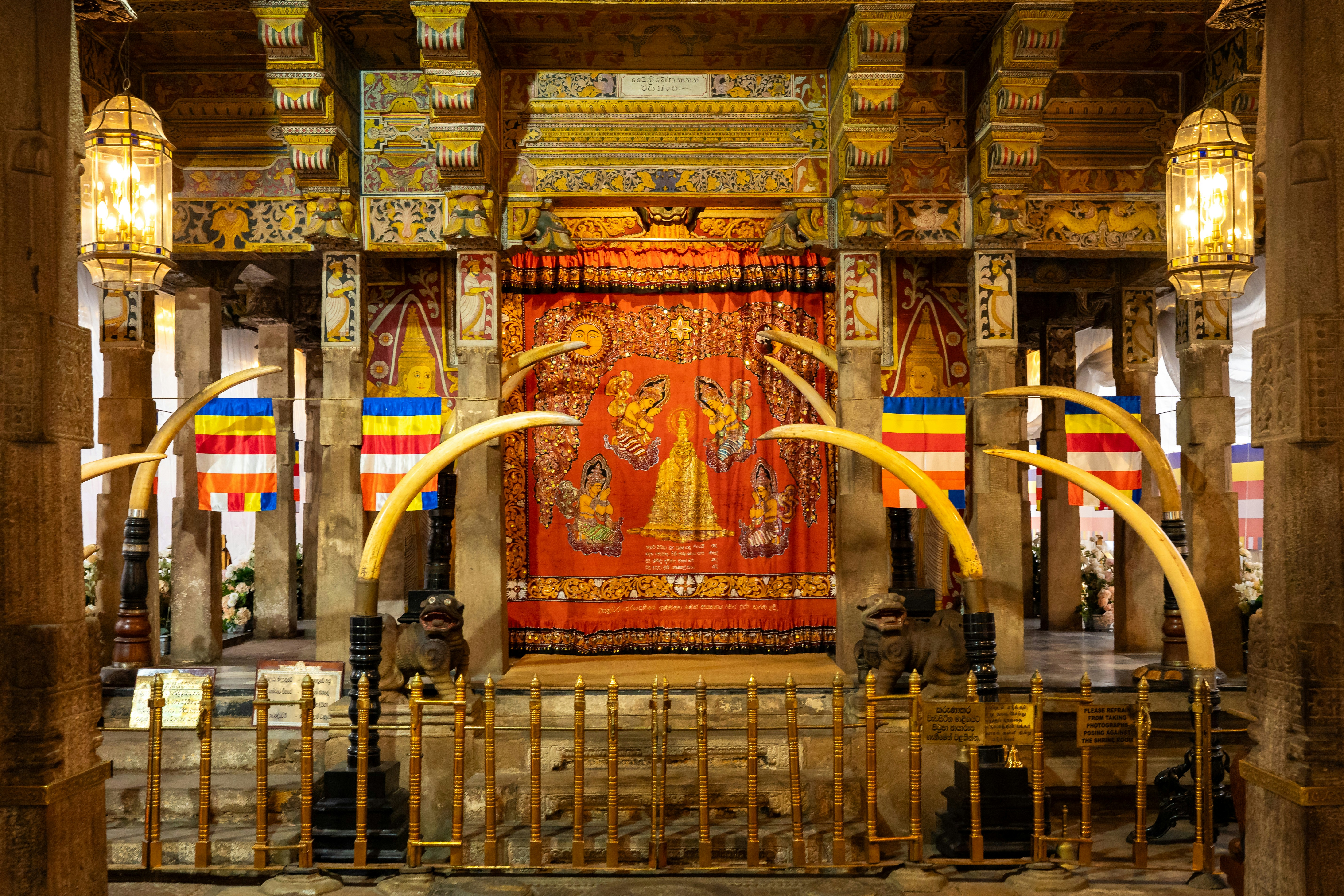 Ornate Temple Hall Framed by Tusked Arches and Bannered Central Tapestry
