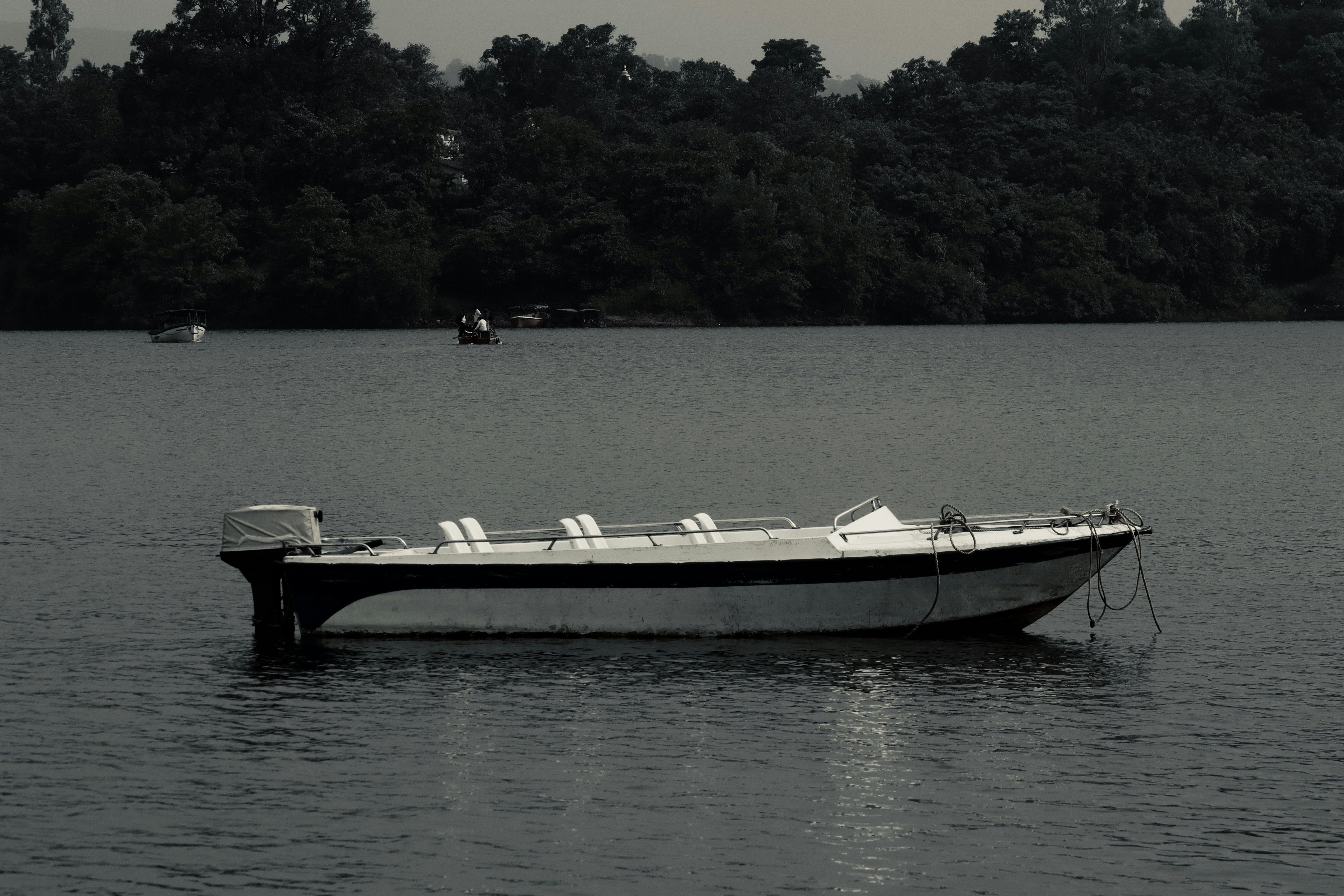 Boat Drifting on a Quiet Lake at Dusk