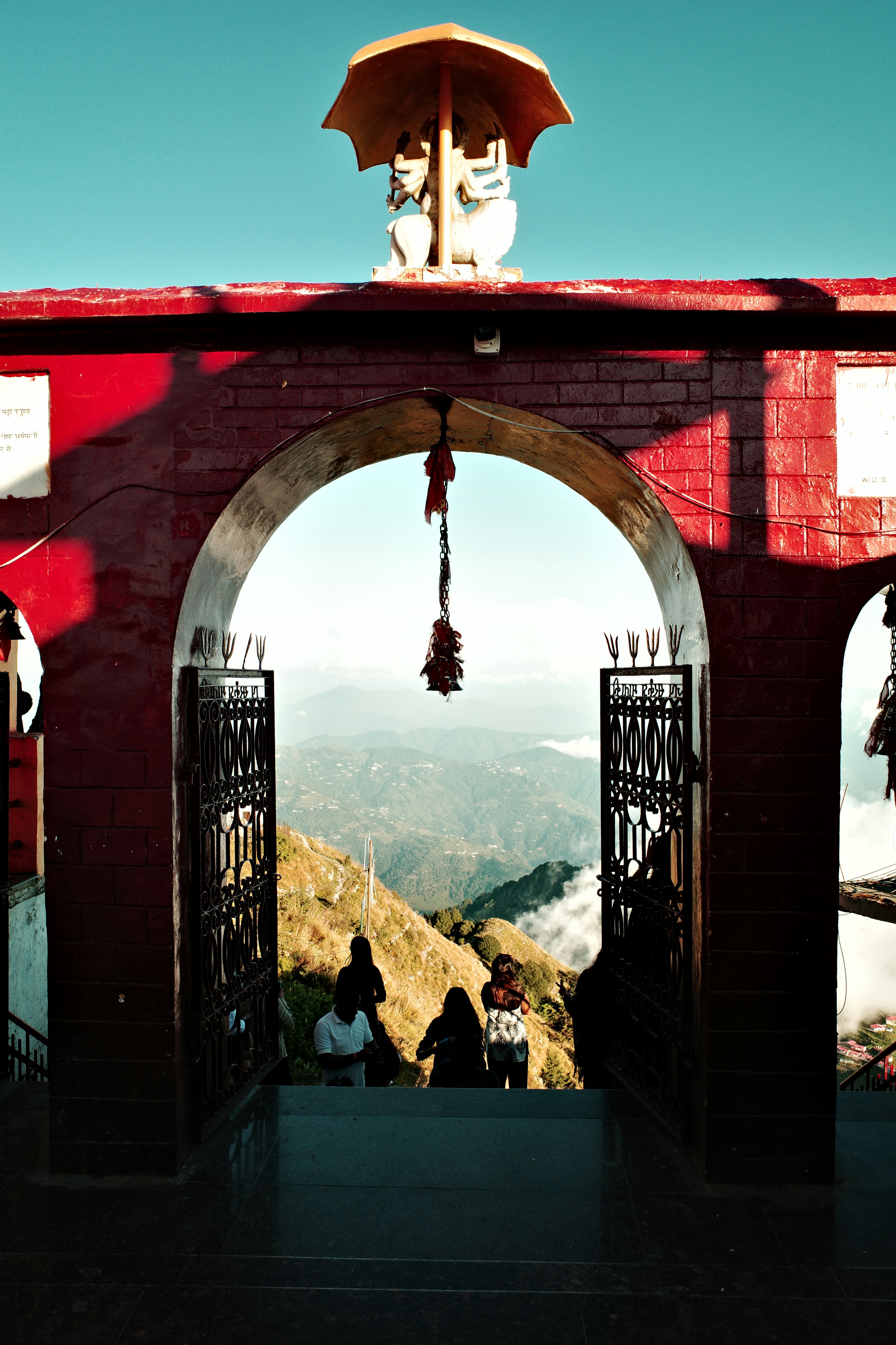 Gate to the Panorama: People in the Archframe Beneath a Red Shrine