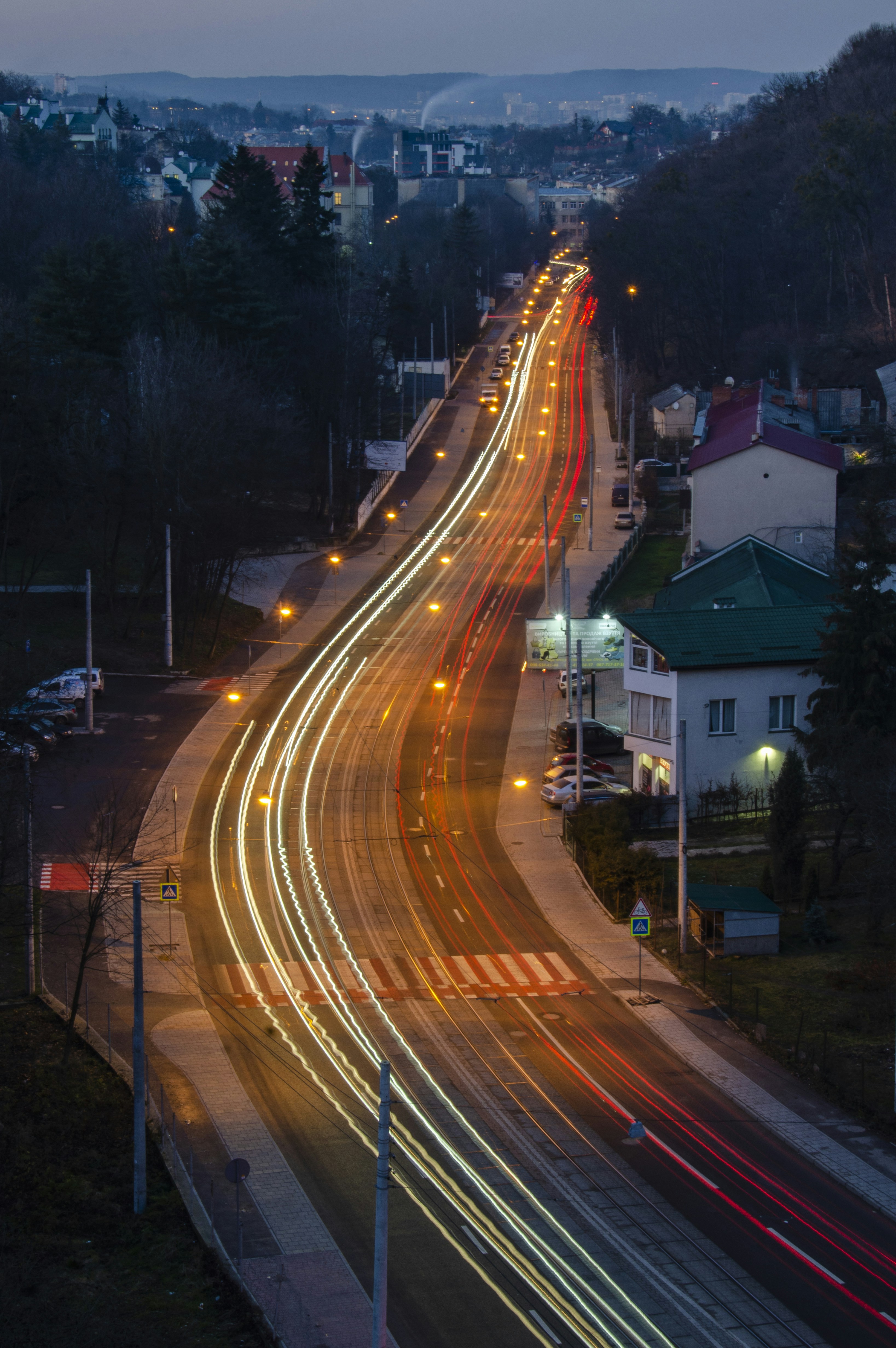 Evening Corridor: Light Trails Weaving Through a Quiet Street