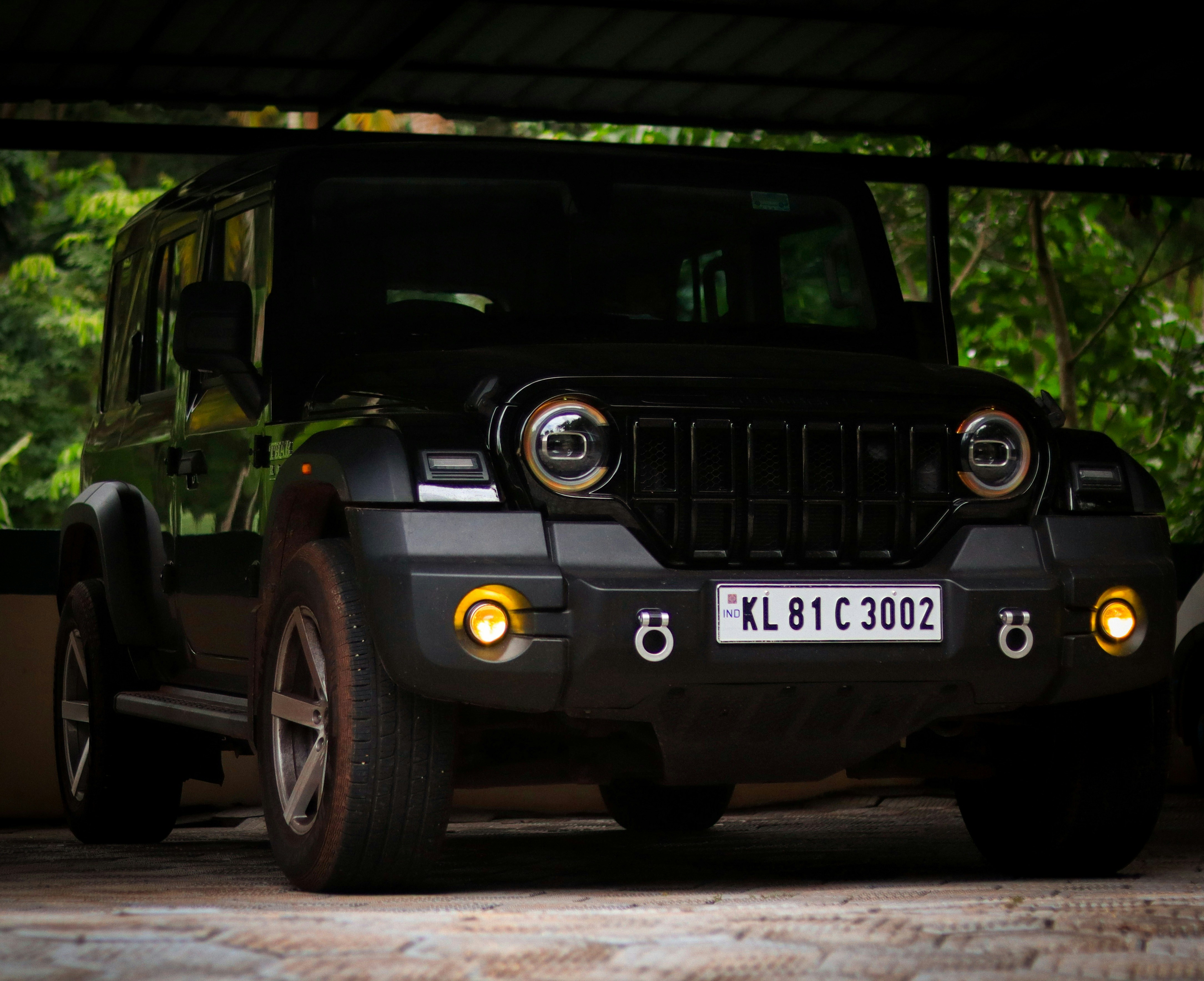 Barely Hidden Power: A Jeep Under a Shaded Canopy