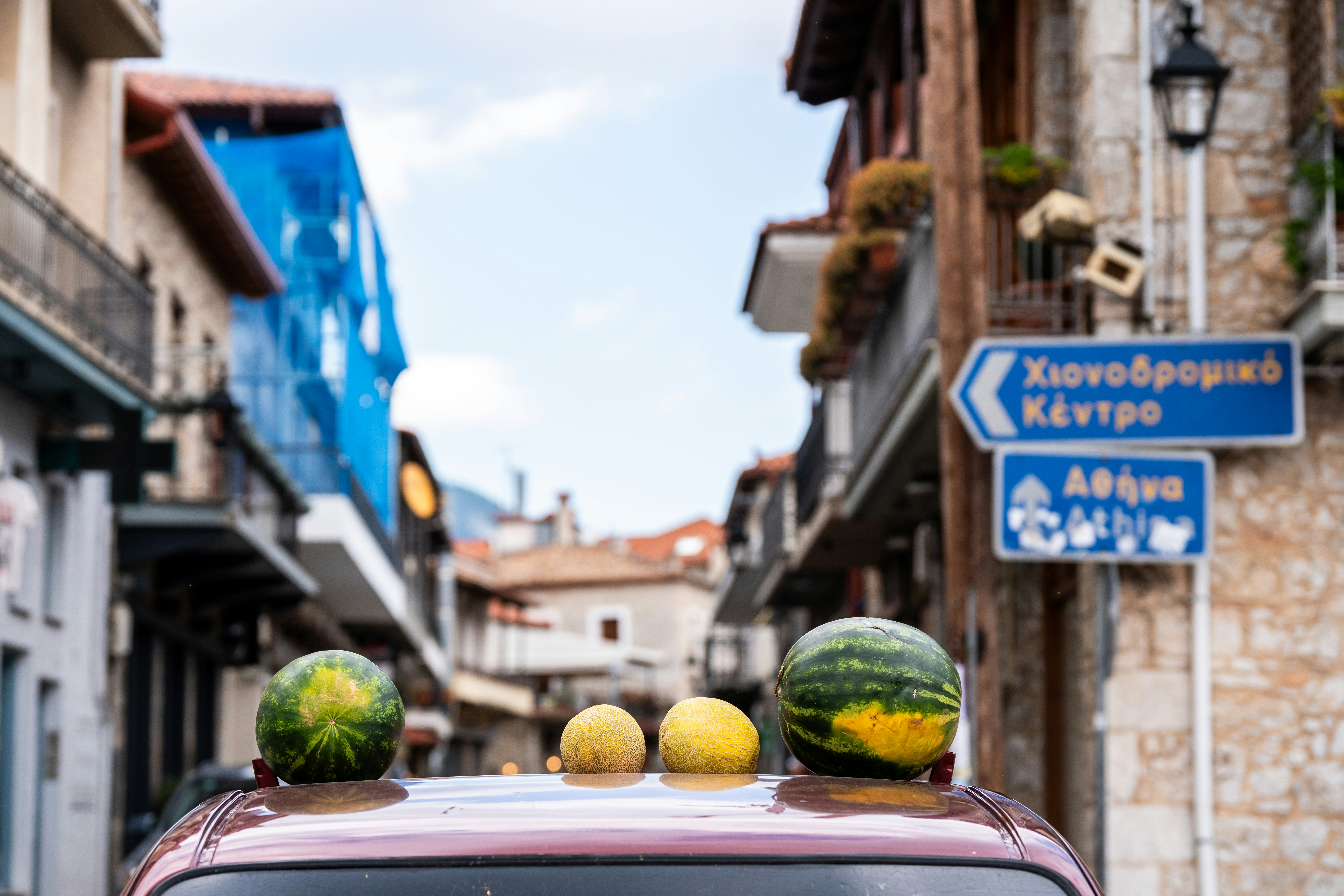 Melon-lidded Skyline: A Retro Roofscape Under Street Signs