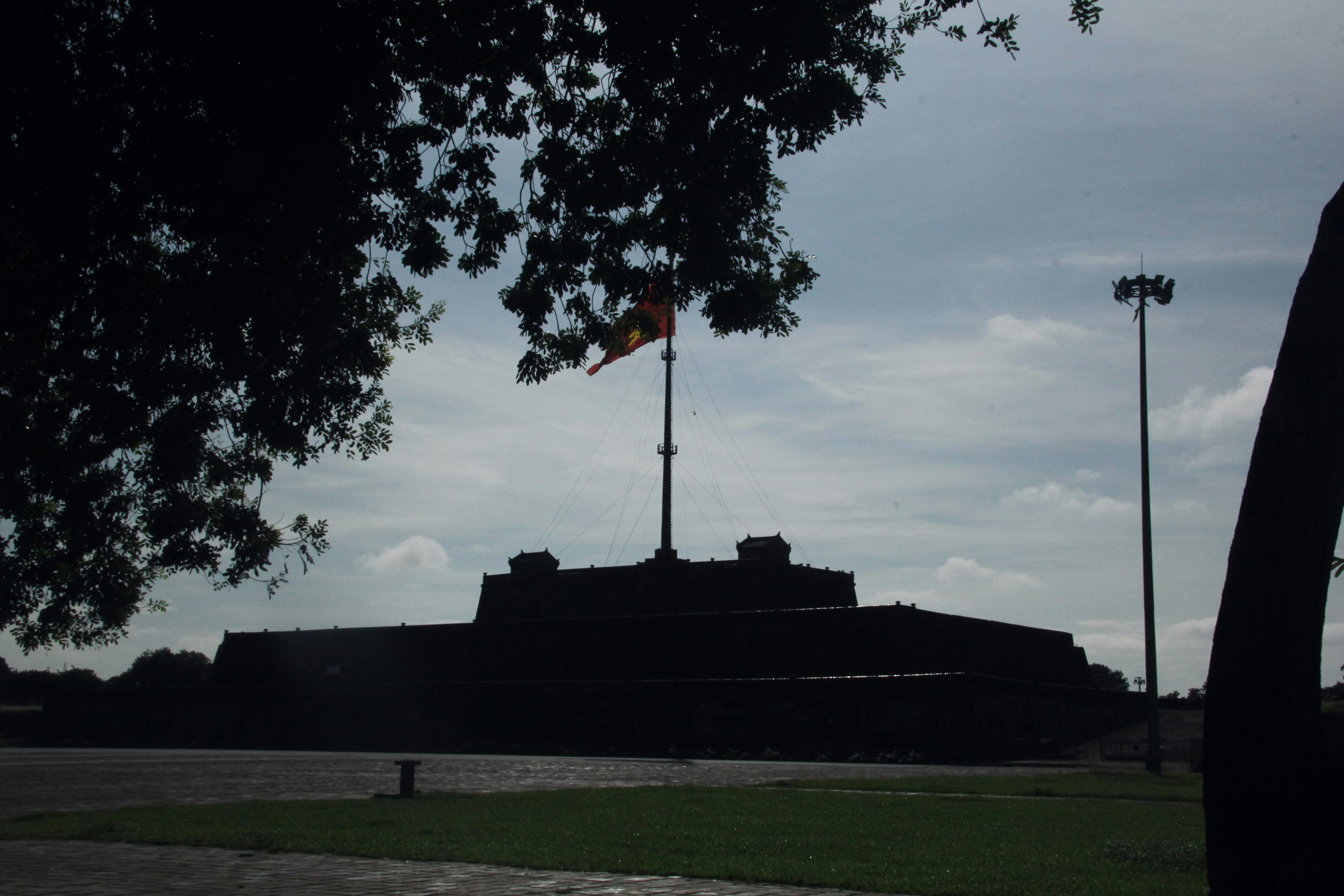 Flag over the silhouette: quiet fortress by the river