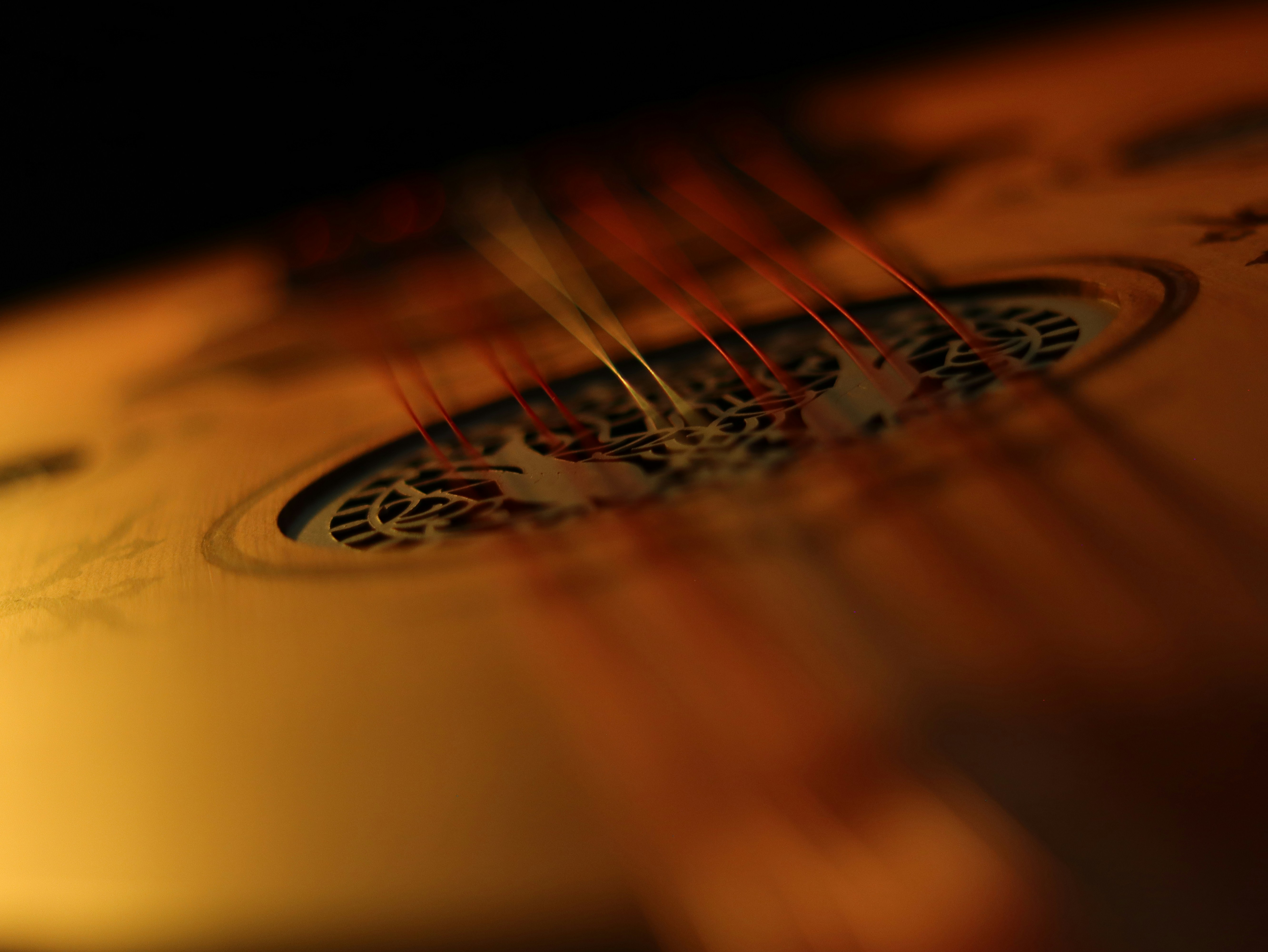 Warm Golden Echoes: The Guitar’s Soundhole in Soft Focus