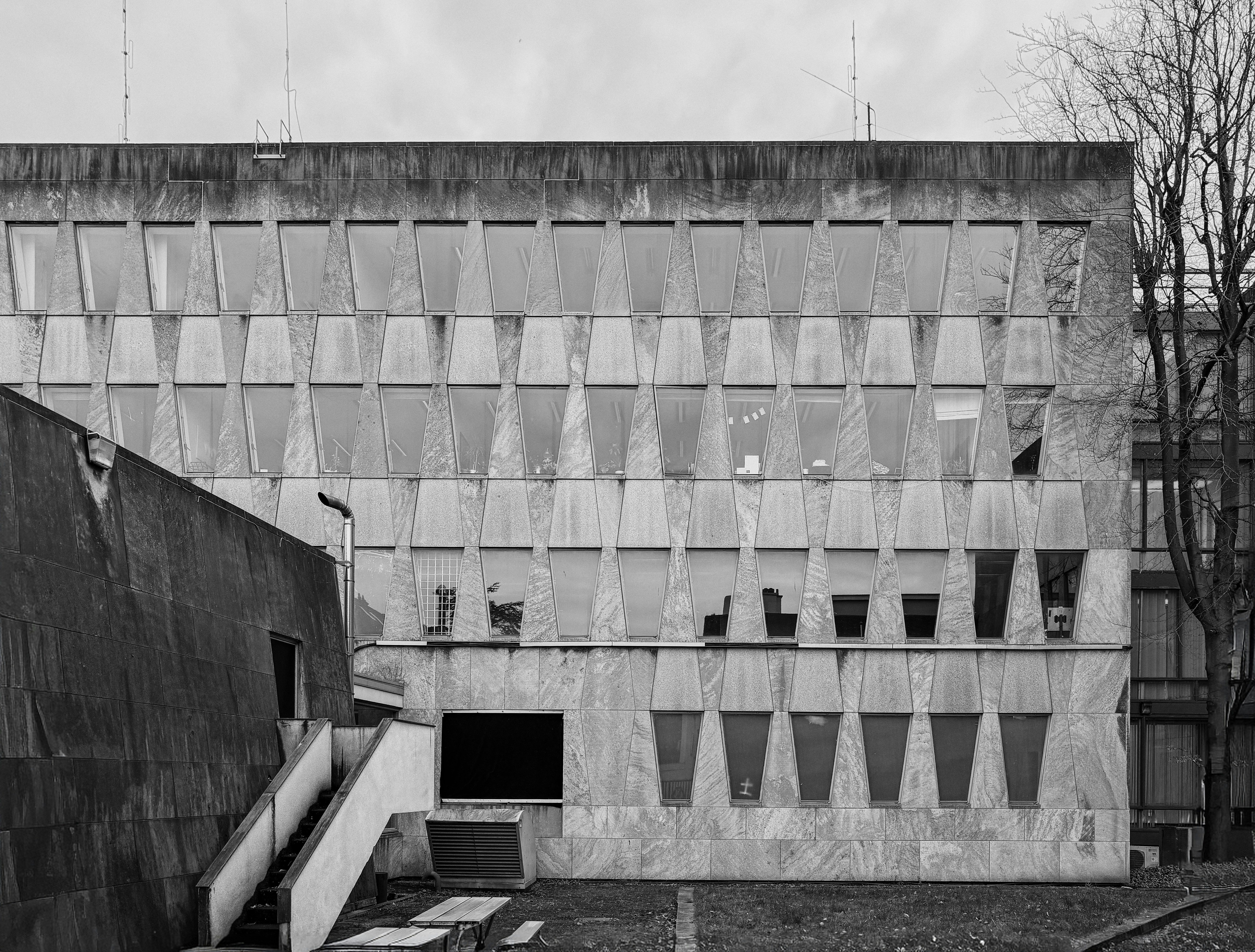 Geometric Facade Echoes: A Monochrome Industrial Scene