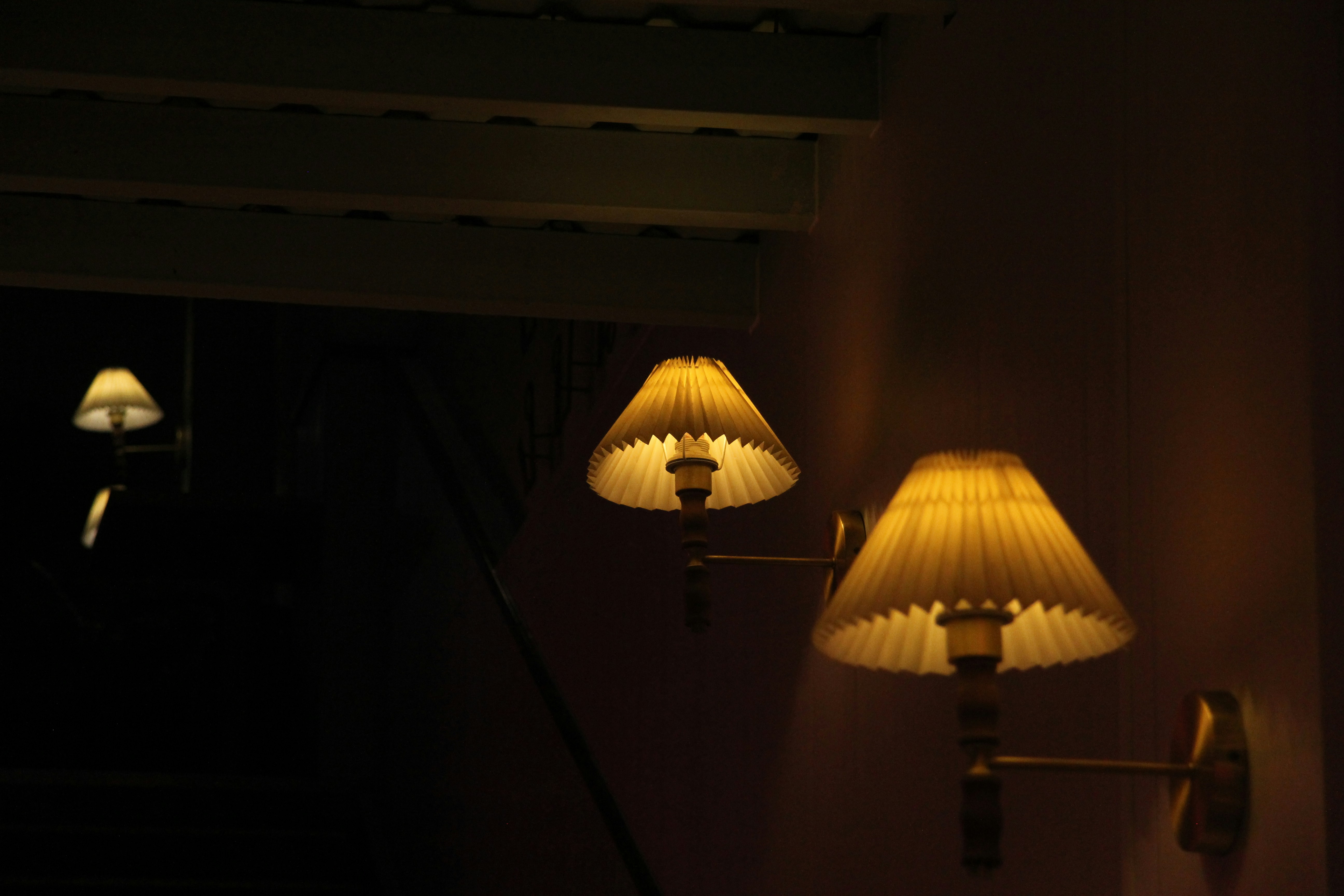 Lamps on a Dim Stairwell: Warm Glows in a Quiet Interior