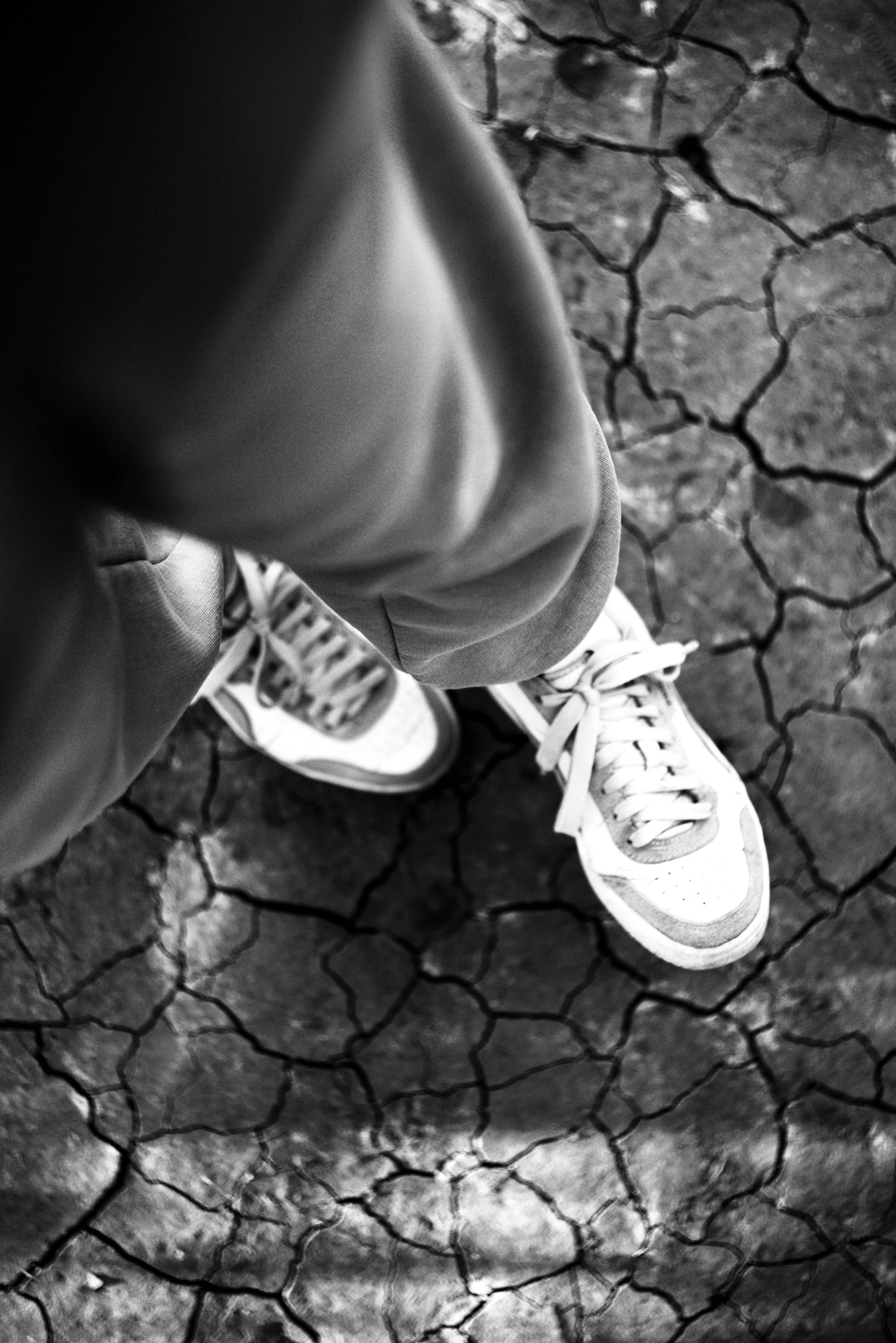 Footsteps on Cracked Ground: A Casual Step into Monochrome Motion
