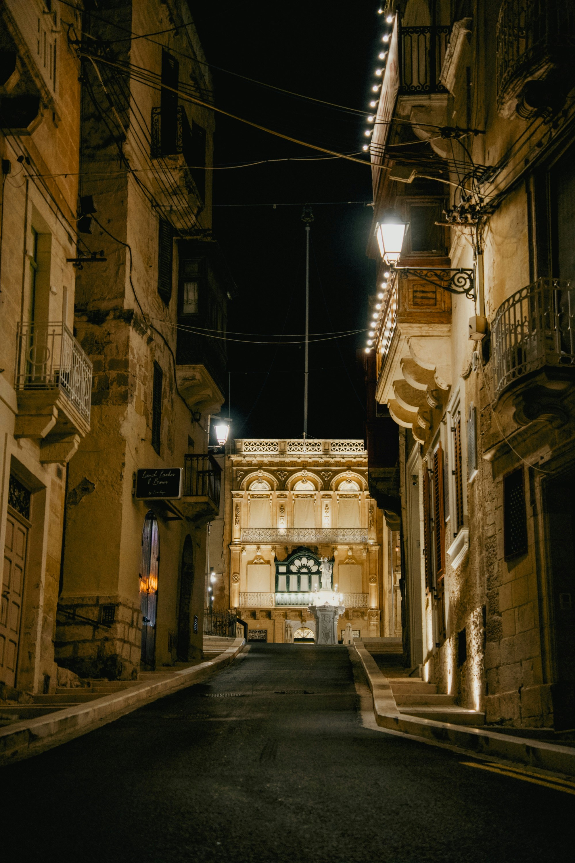Lanterns over the ancient incline: a night ascent to the illuminated facade