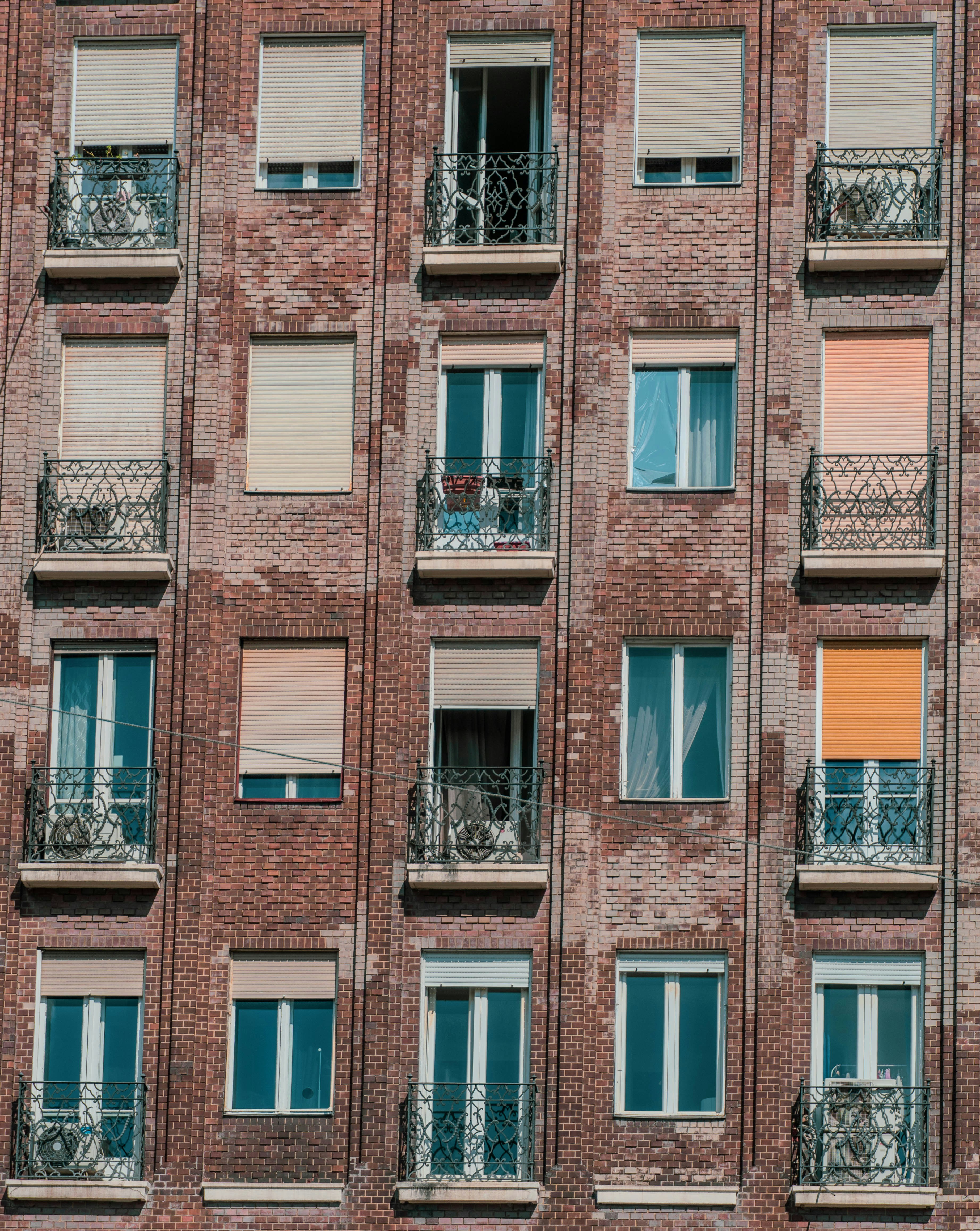 Brick Mosaic: Row of Ornate Balconies and Shuttered Windows