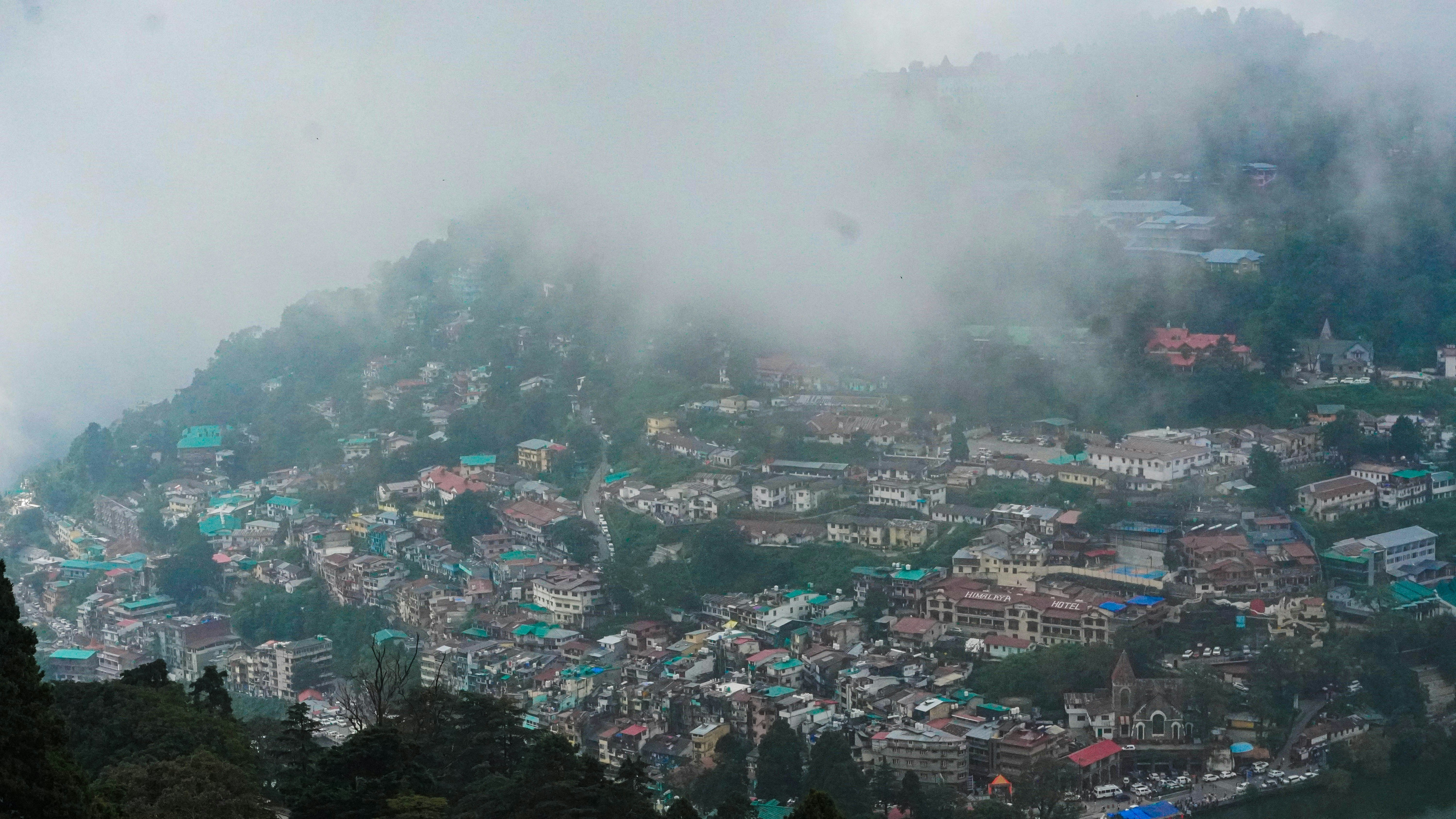 Mist over the hillside town: a sleepy valley awakening
