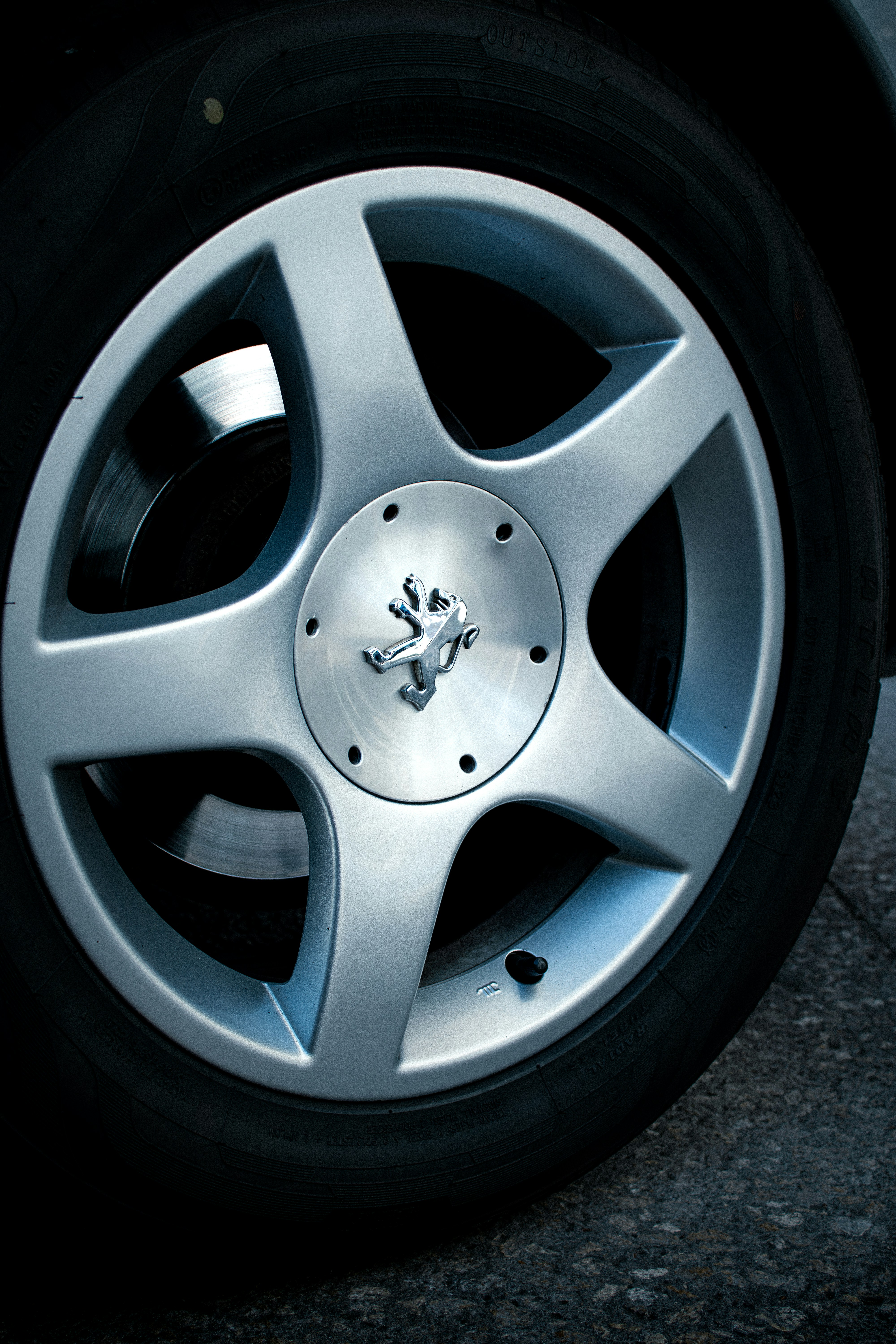 Silver Peugeot Wheel: A Close-Up of Chrome and Rim Detail