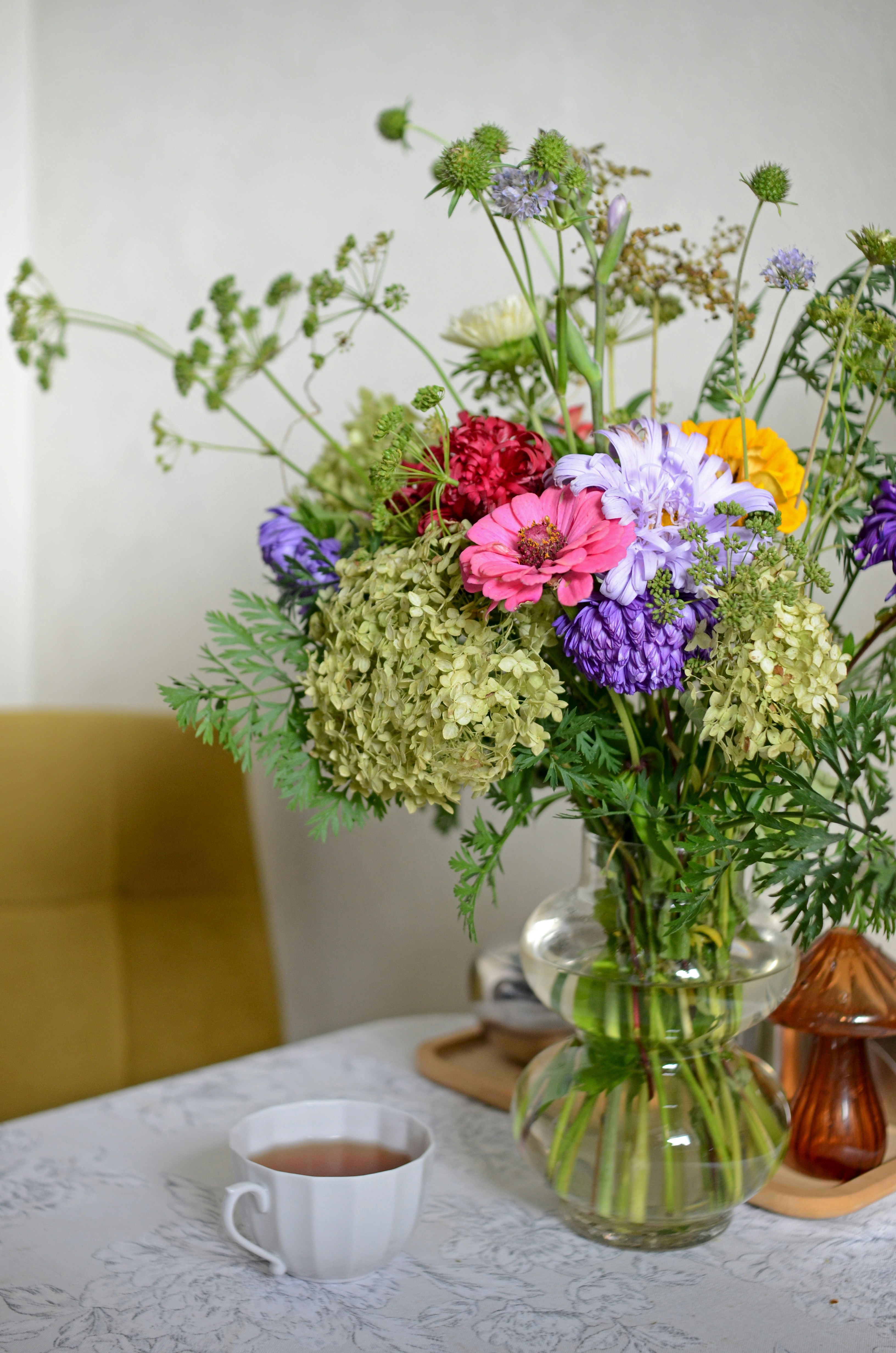 Vibrant Floral Cascade Over a Quiet Tea Table