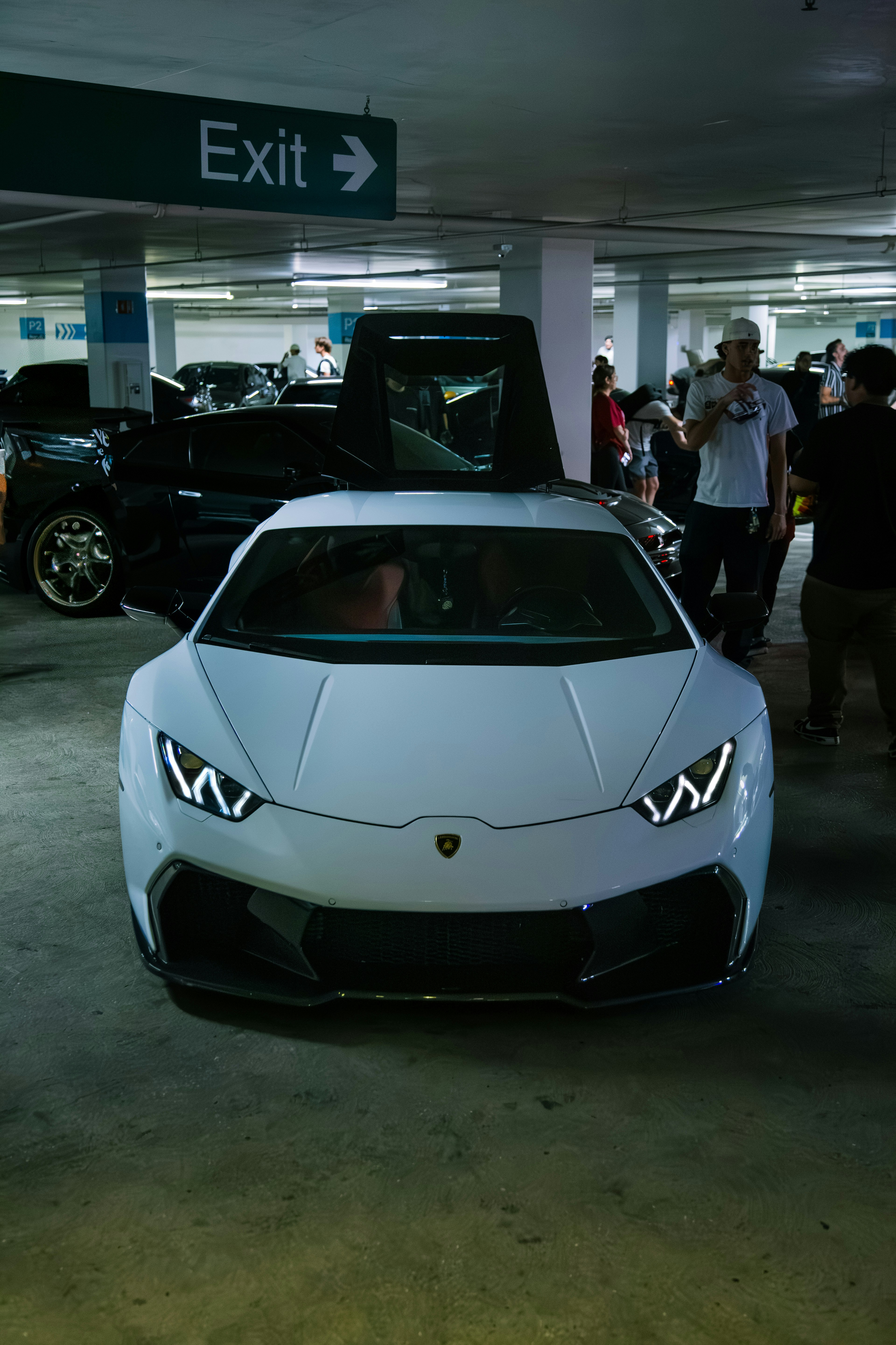 White Lamborghini Huracan in a Parking Garage with Doors Raised