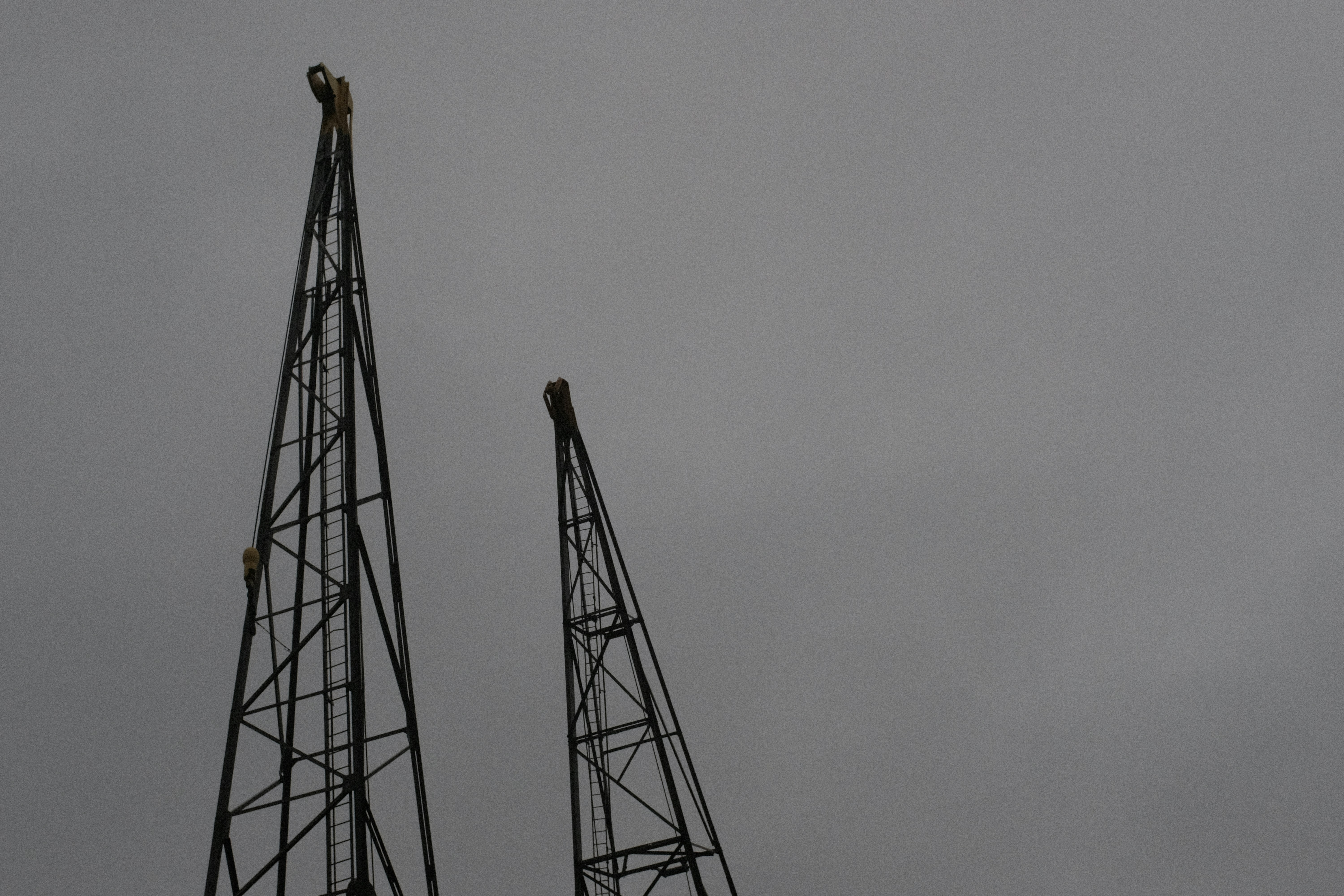 Tall Cranes against a Matte Sky