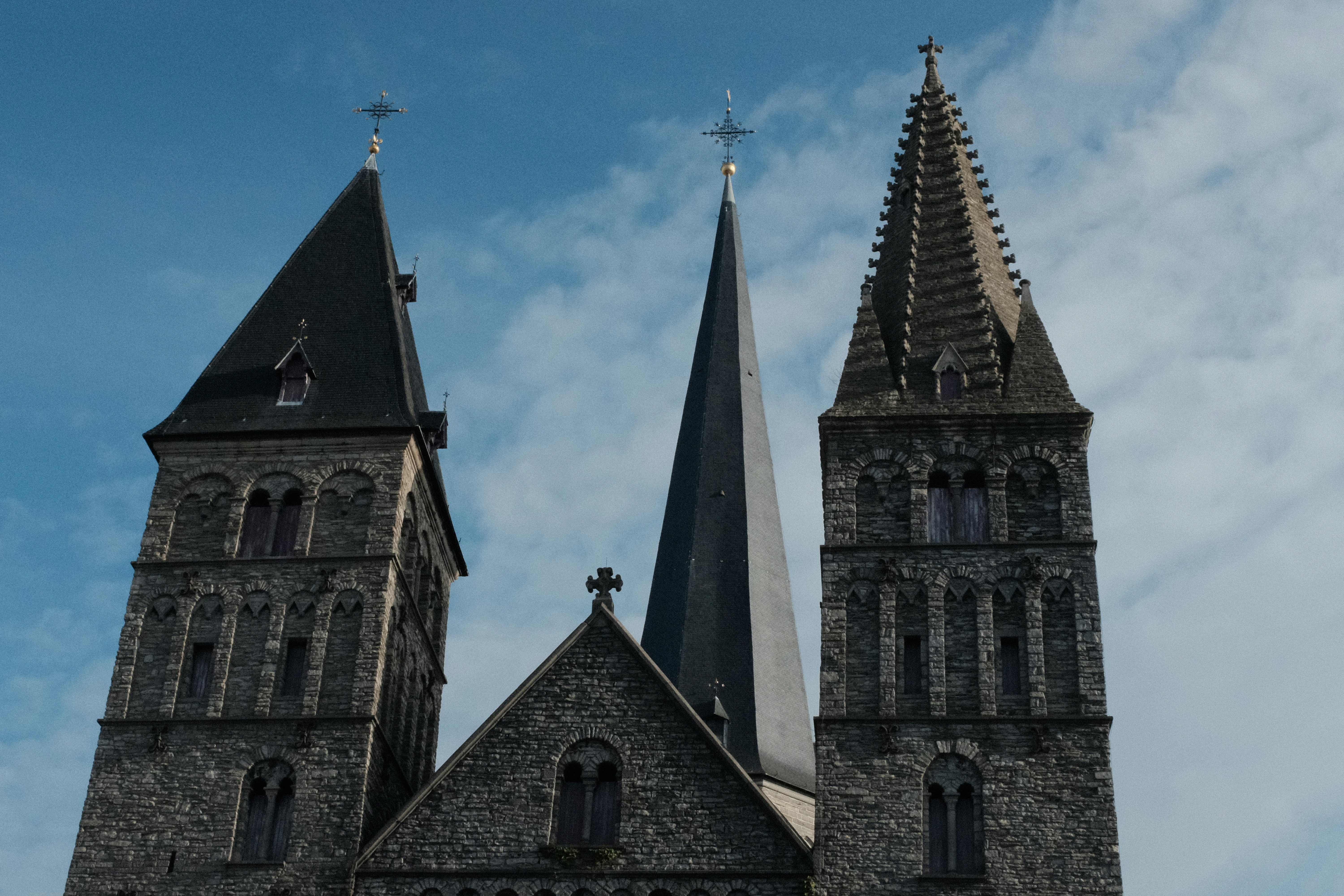 Triple Spires at Dusk: A Gothic Church silhouette Against a Clear Sky