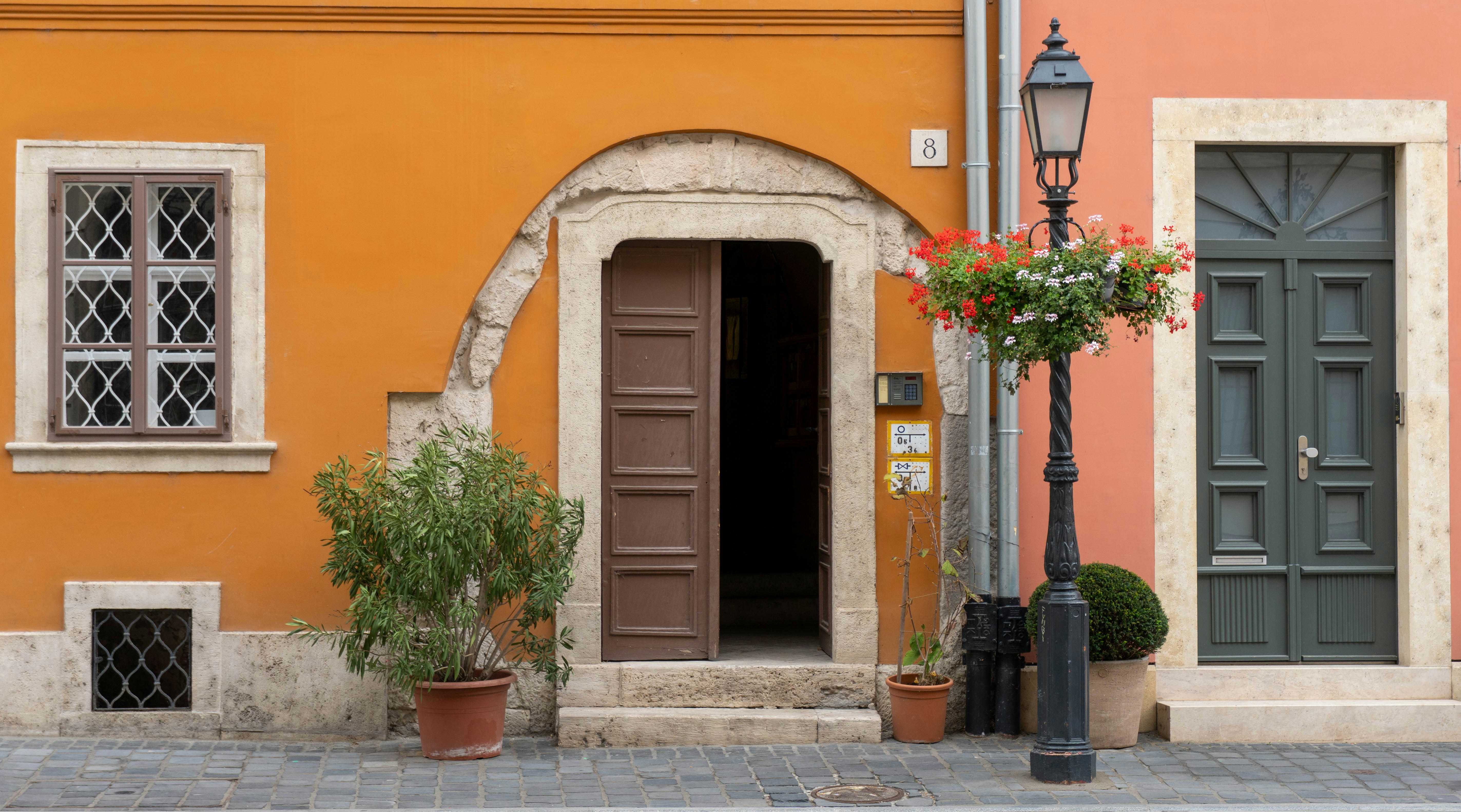 Portal Between Warm Facades: A Quiet Street Entrance