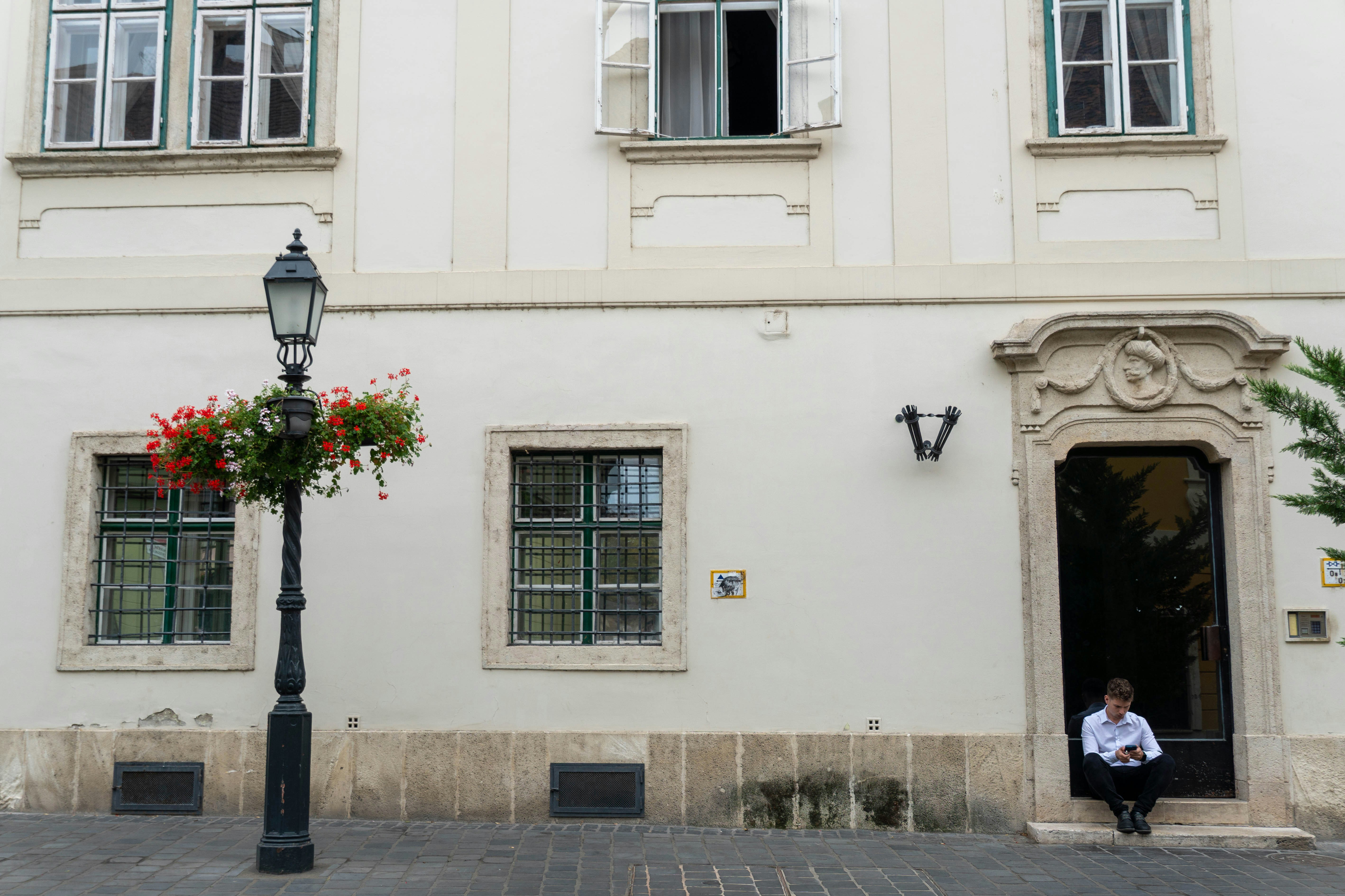 Person Occupies the Threshold: Quiet Presence by the Porch