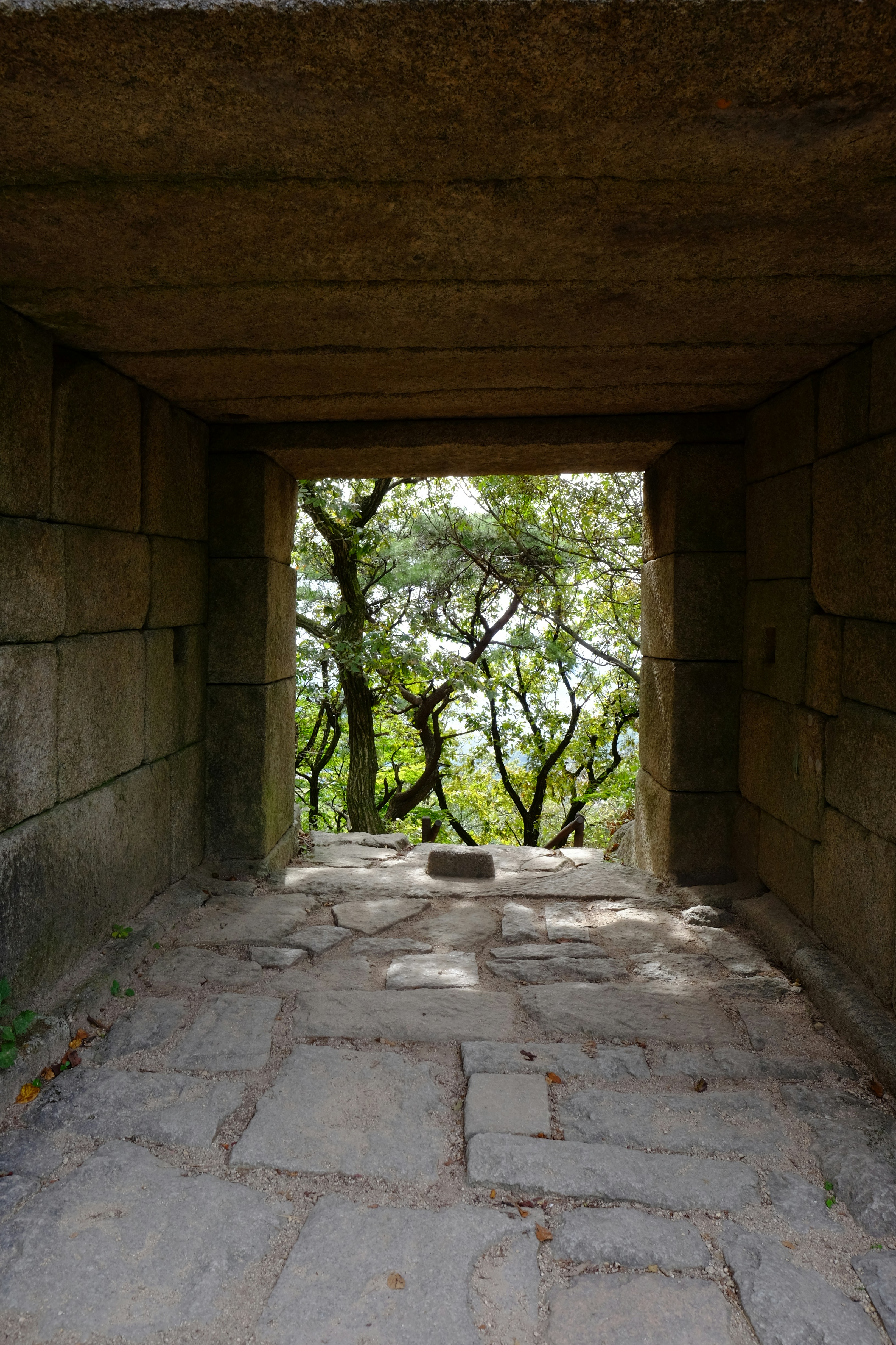 Stone Corridor to a Sunlit Terrace