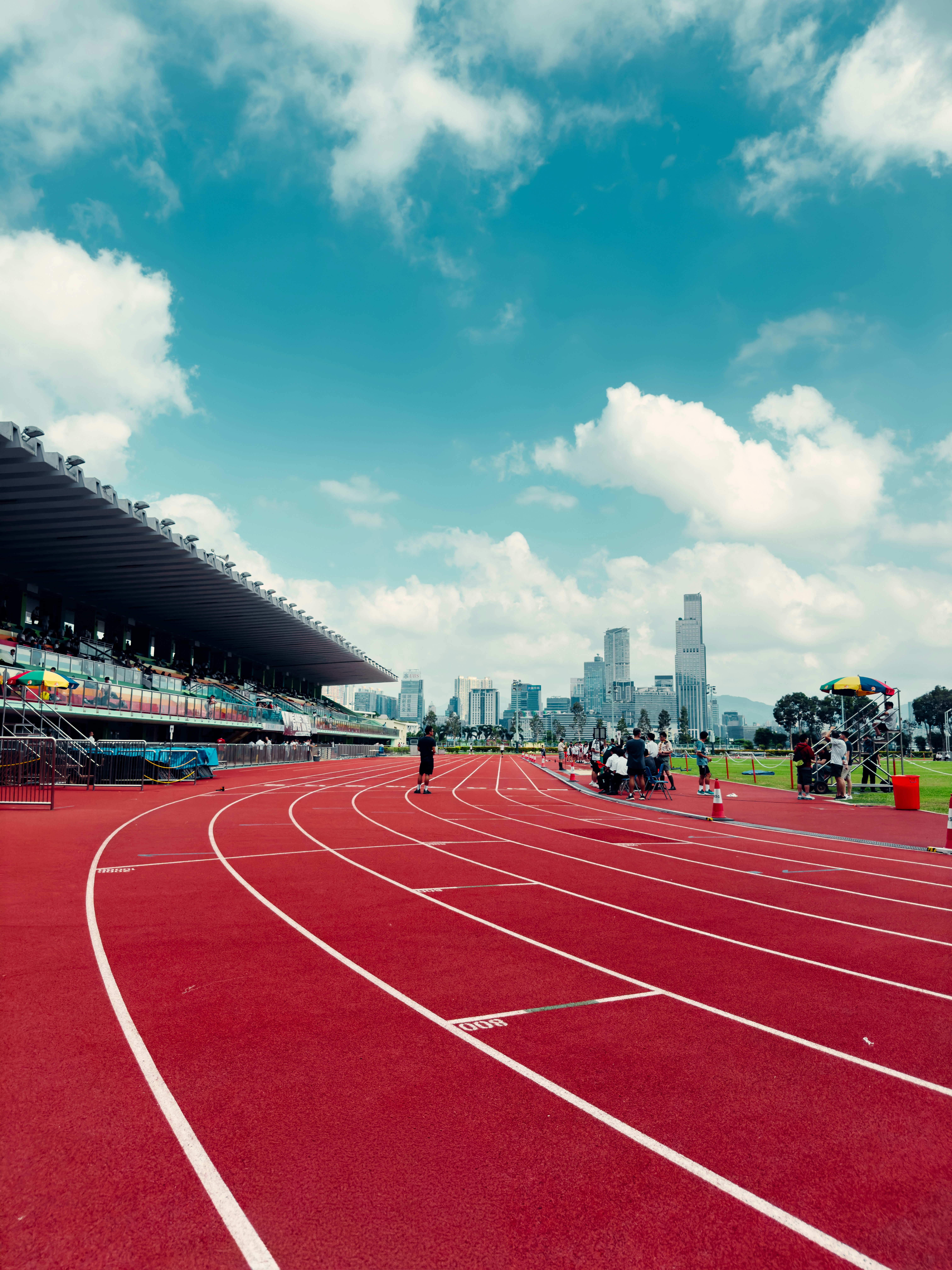 Red Track to the City: A Sunlit Sprint toward the Skyline