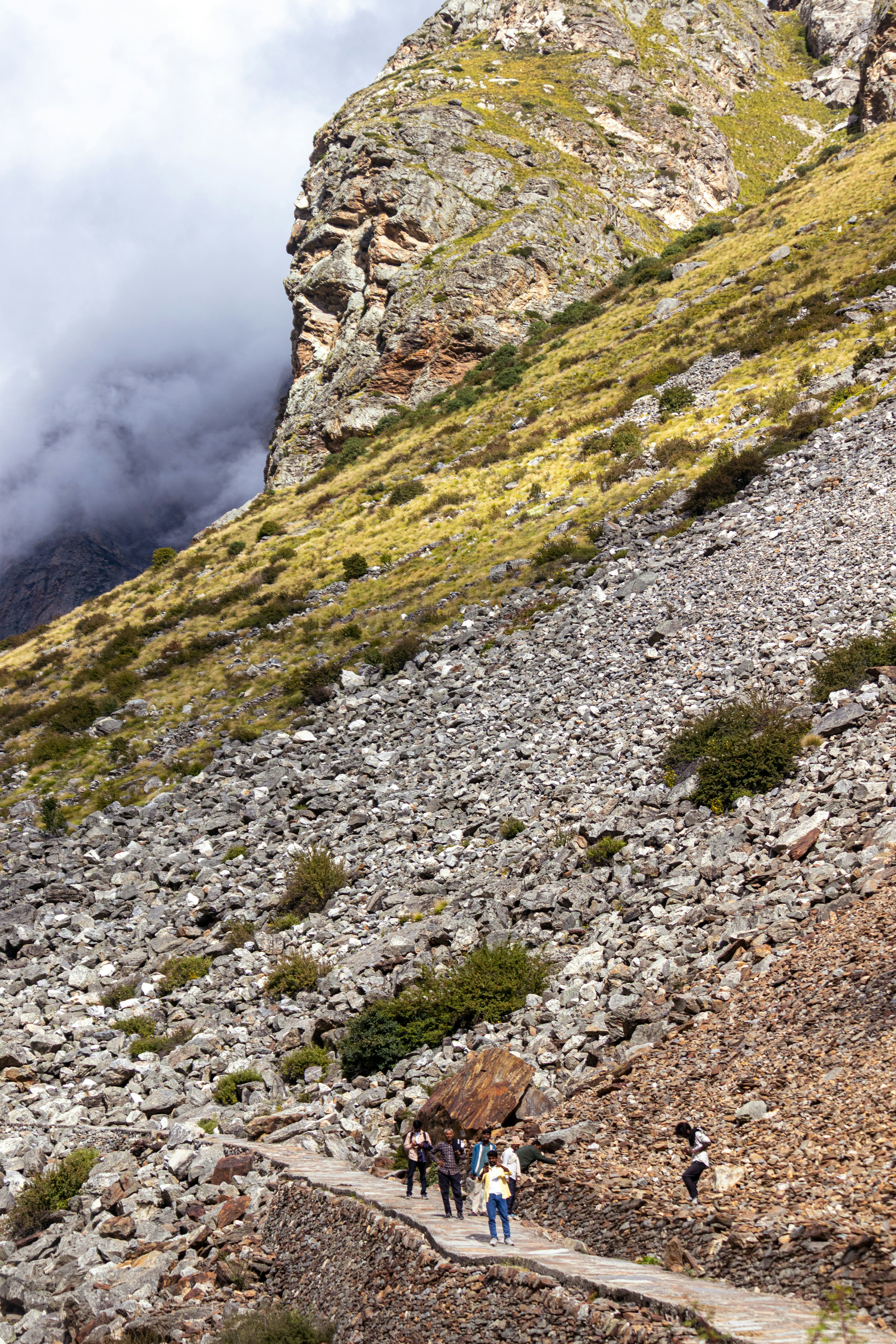 Trail Beneath a Jagged Expanse: Climbers Climb the Talus Path
