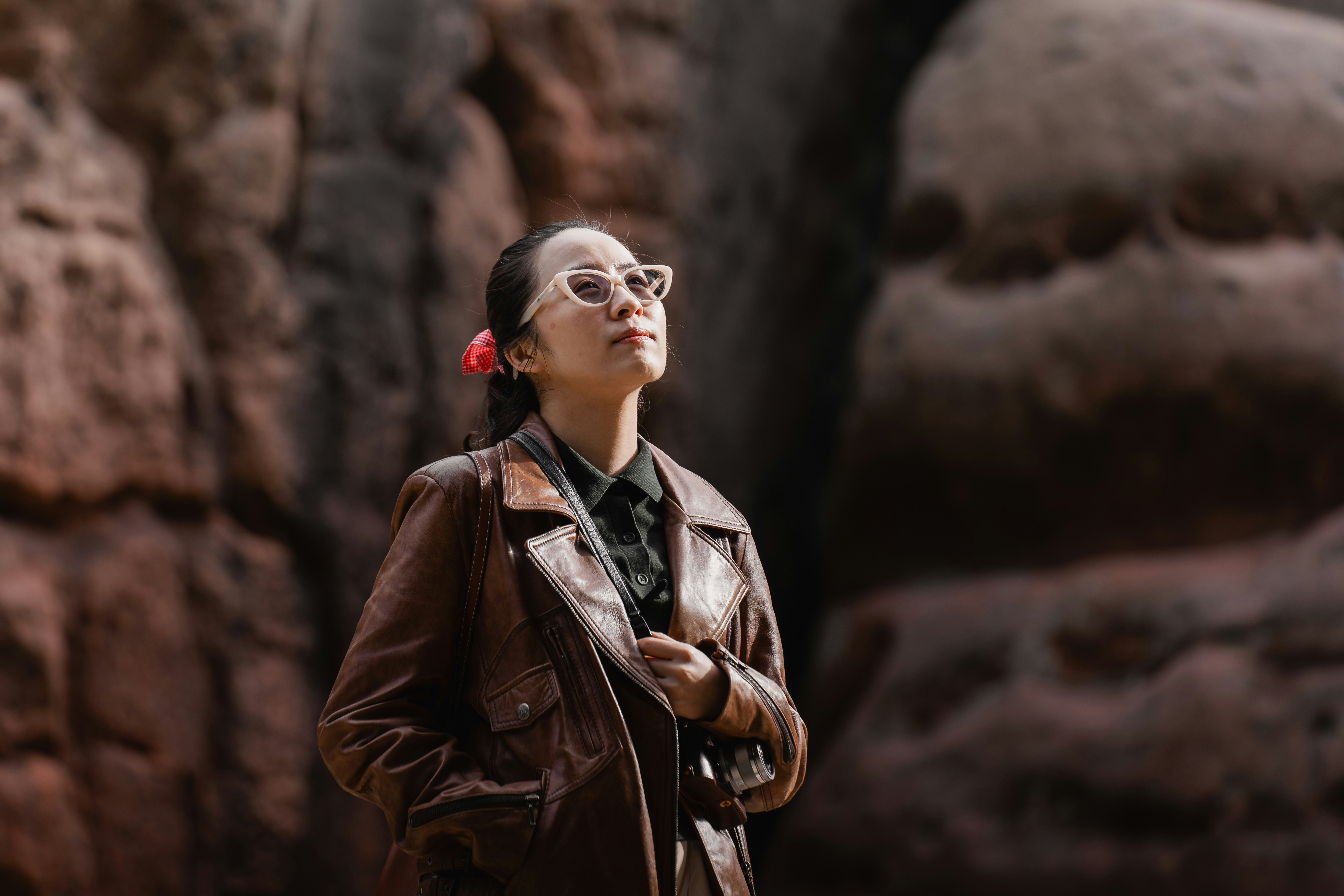 Portrait of a Woman Gazing Upward Among Red Sandstone Cliffs