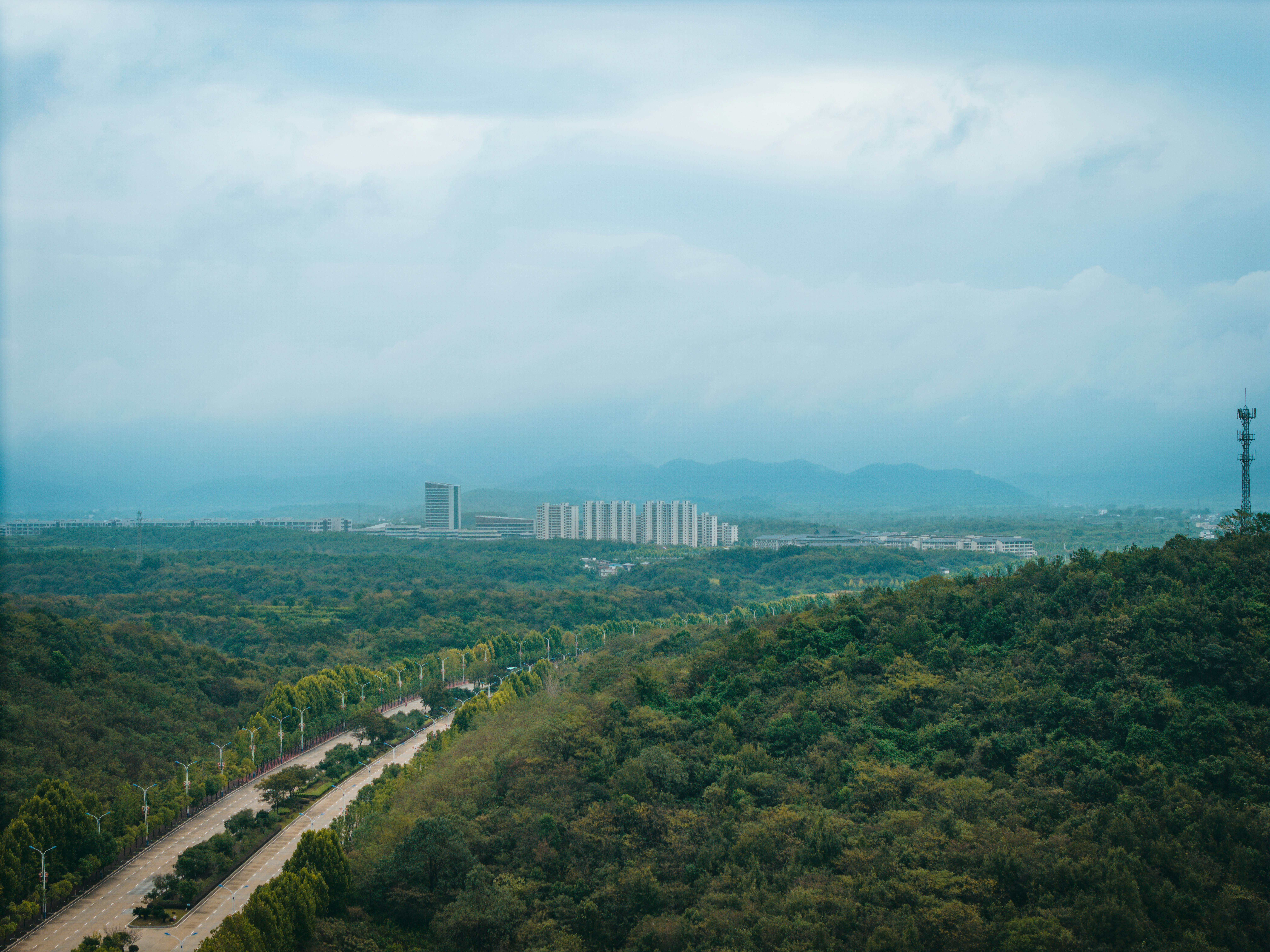 Urban Crest on the Horizon: A Drone’s View over Green Valleys
