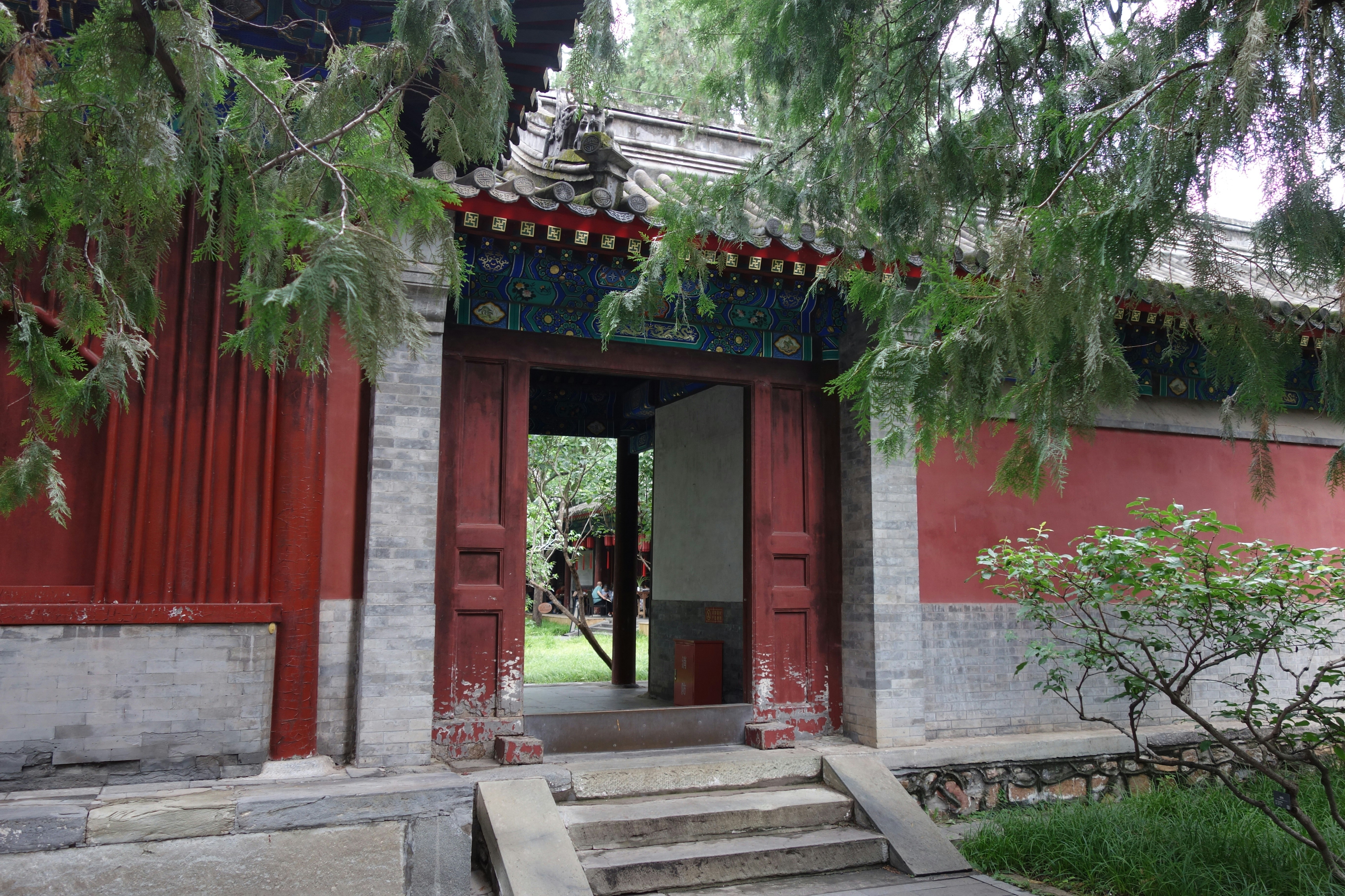 Gate of the Quiet Court: Red Walls, Green Canopy
