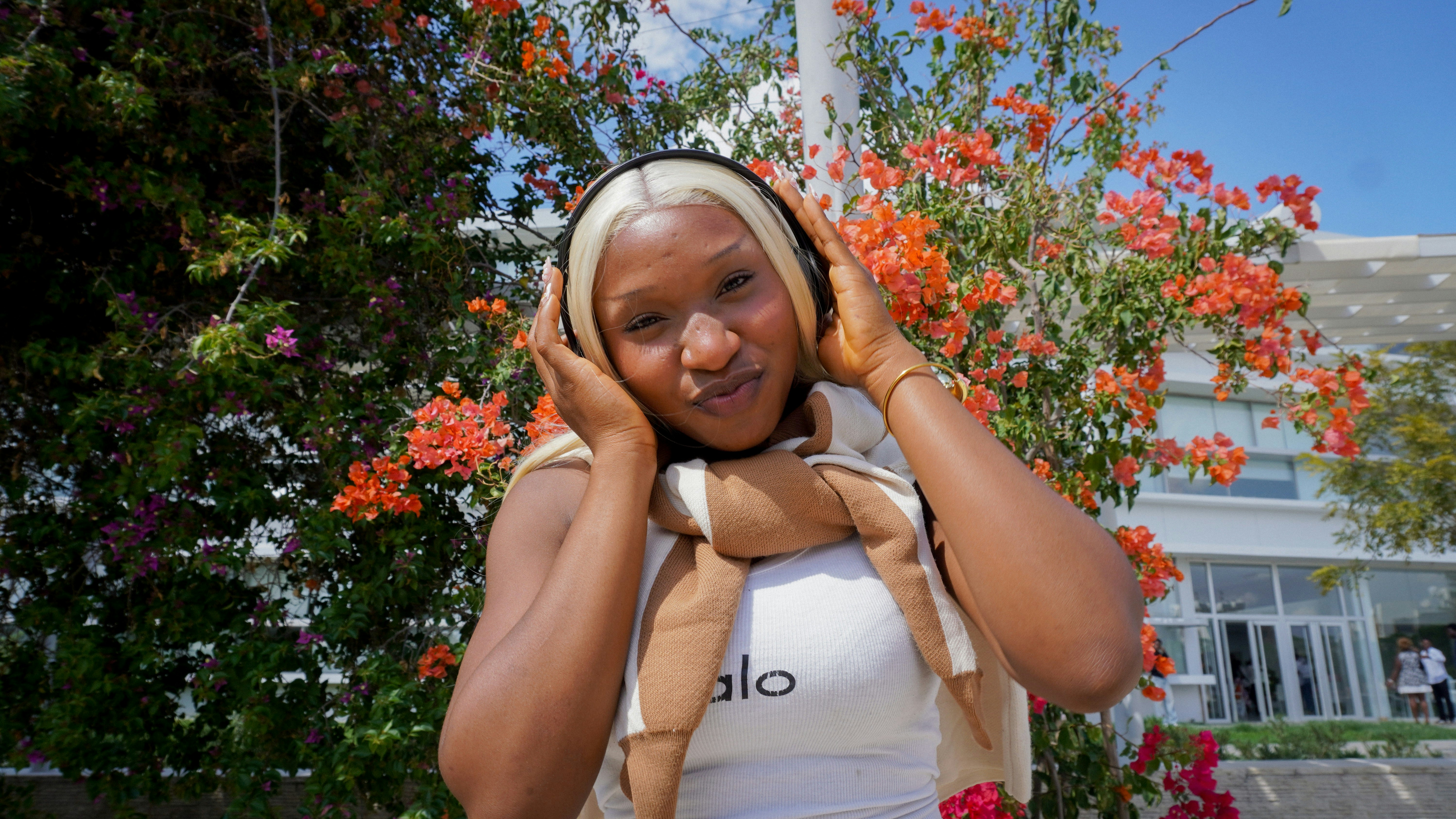 Headphones on the Smile: a sunlit portrait in bloom
