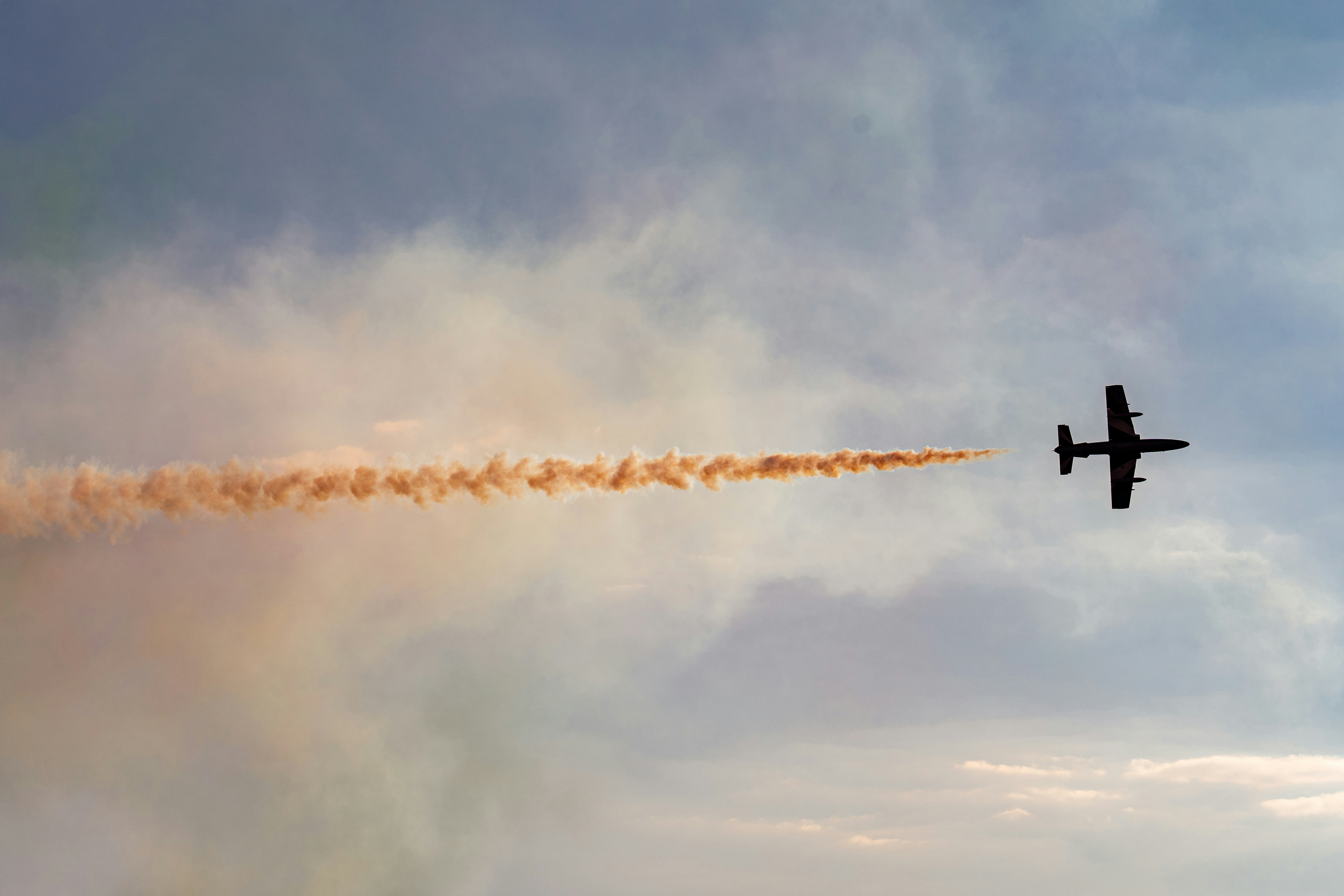Jet in Sky: Smoke Trail Struck by the Sunlit Drift