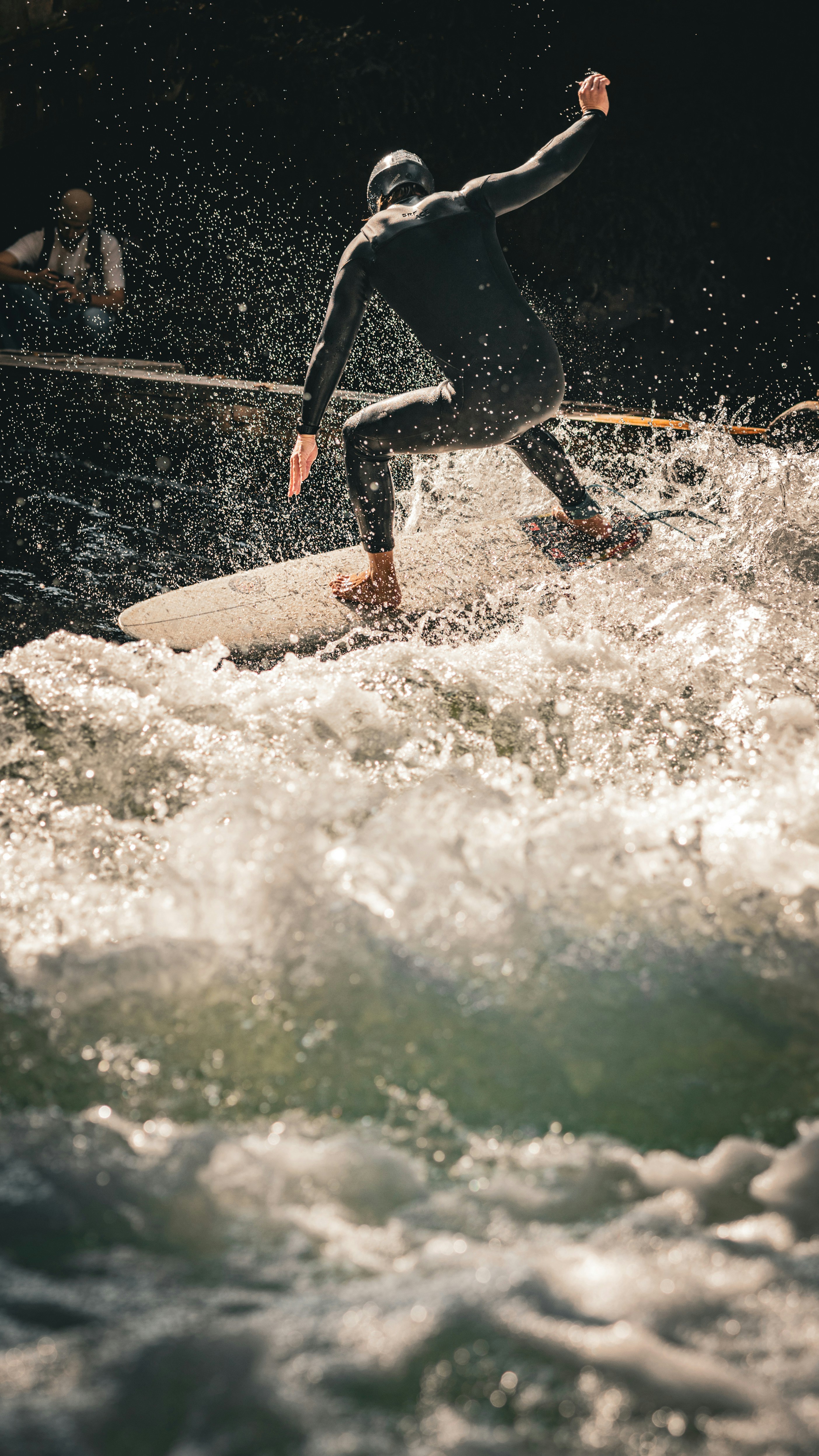 Rider in Shadow: A Surfer’s Arc Through Foam and Light