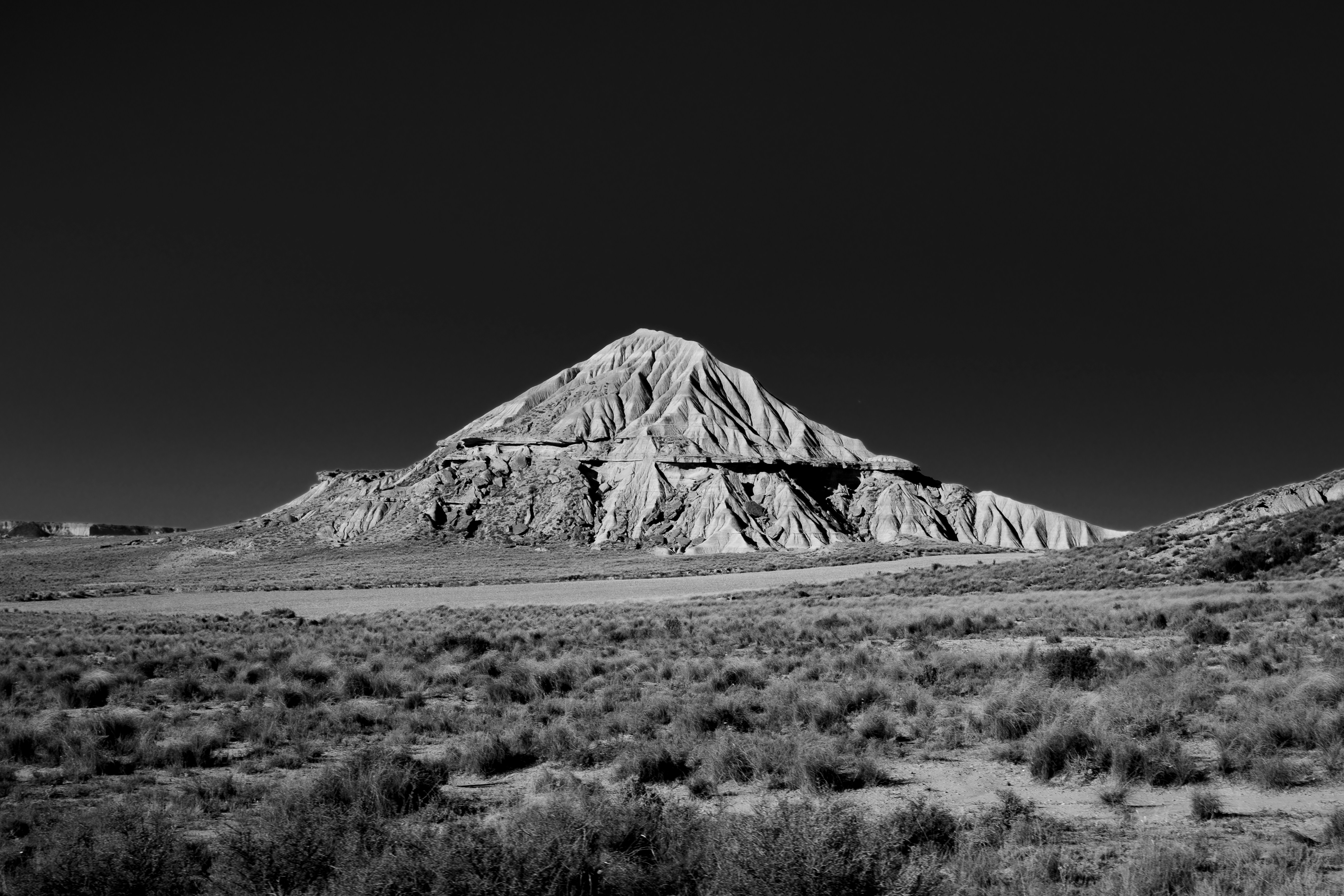 Desert Monument: A Monolithic Mountain Under a Vast Dark Sky