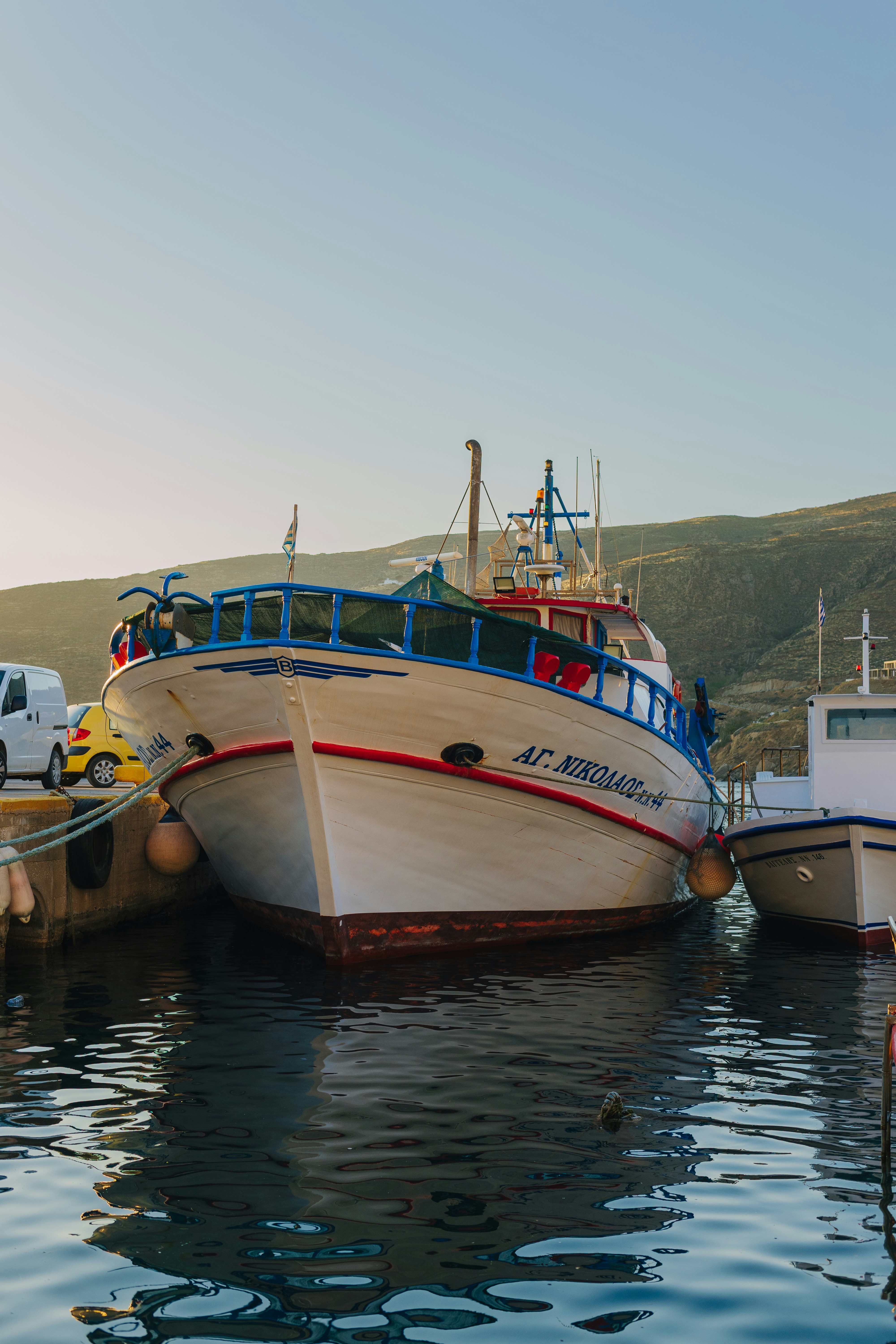 Harbor Vessel at Sunset: A Sturdy Boat Anchored in Quiet Waters