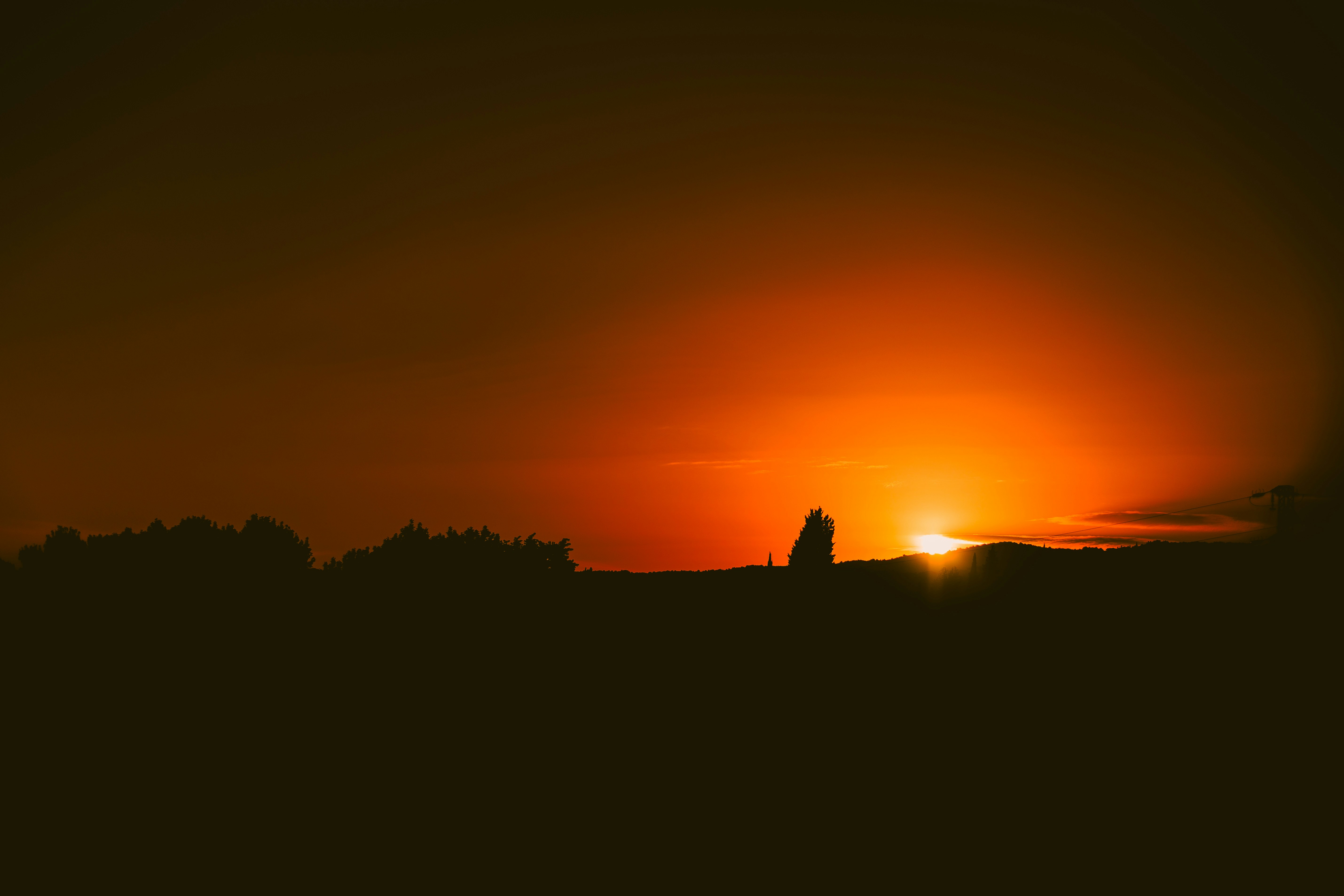 Sunset Silhouette: A Quiet Horizon Basks in Ember Light