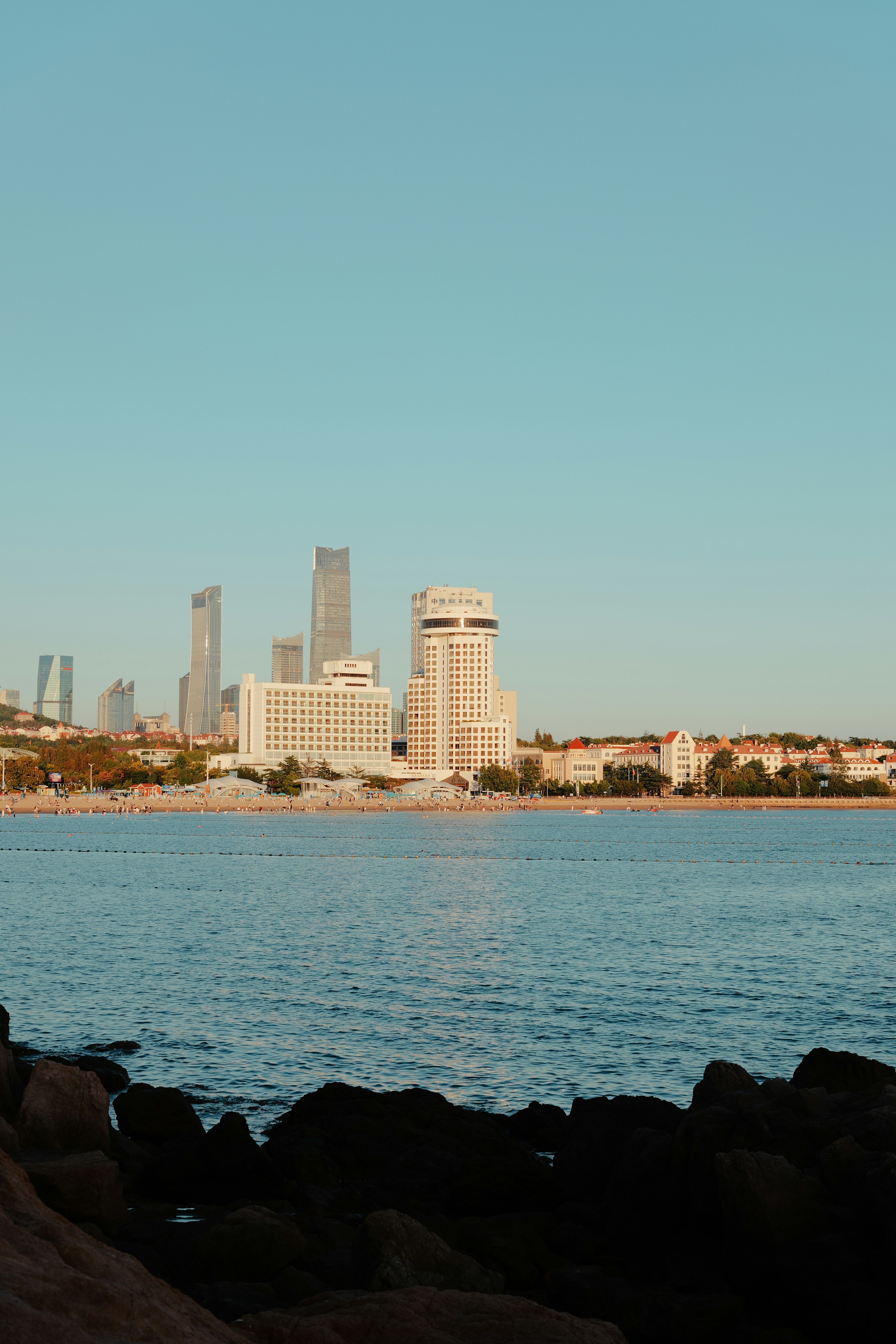 City Skyline by the Calm Sea at Dusk