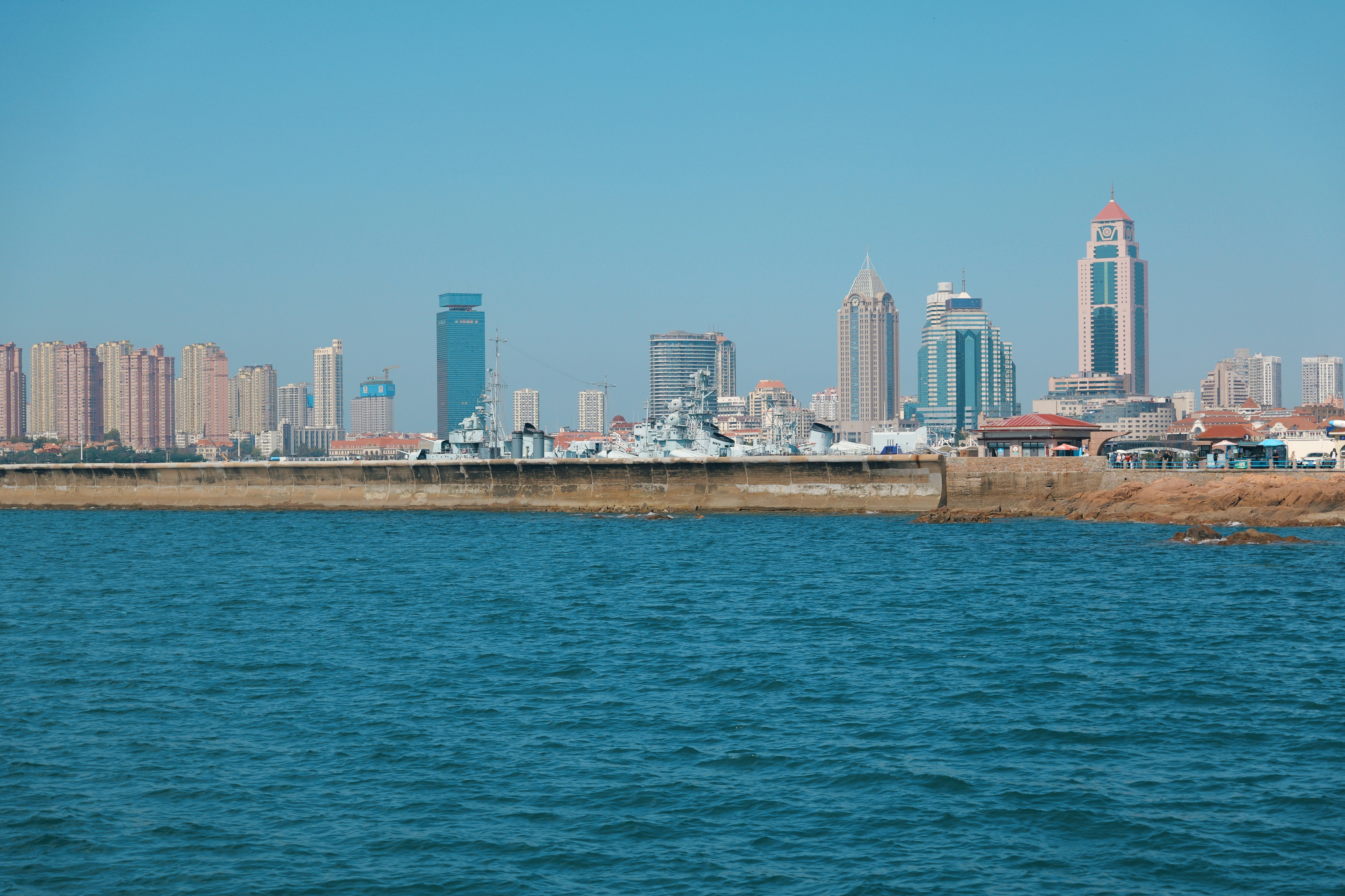 Harbor Line: Distant Skyline Over Calm Blue Waters