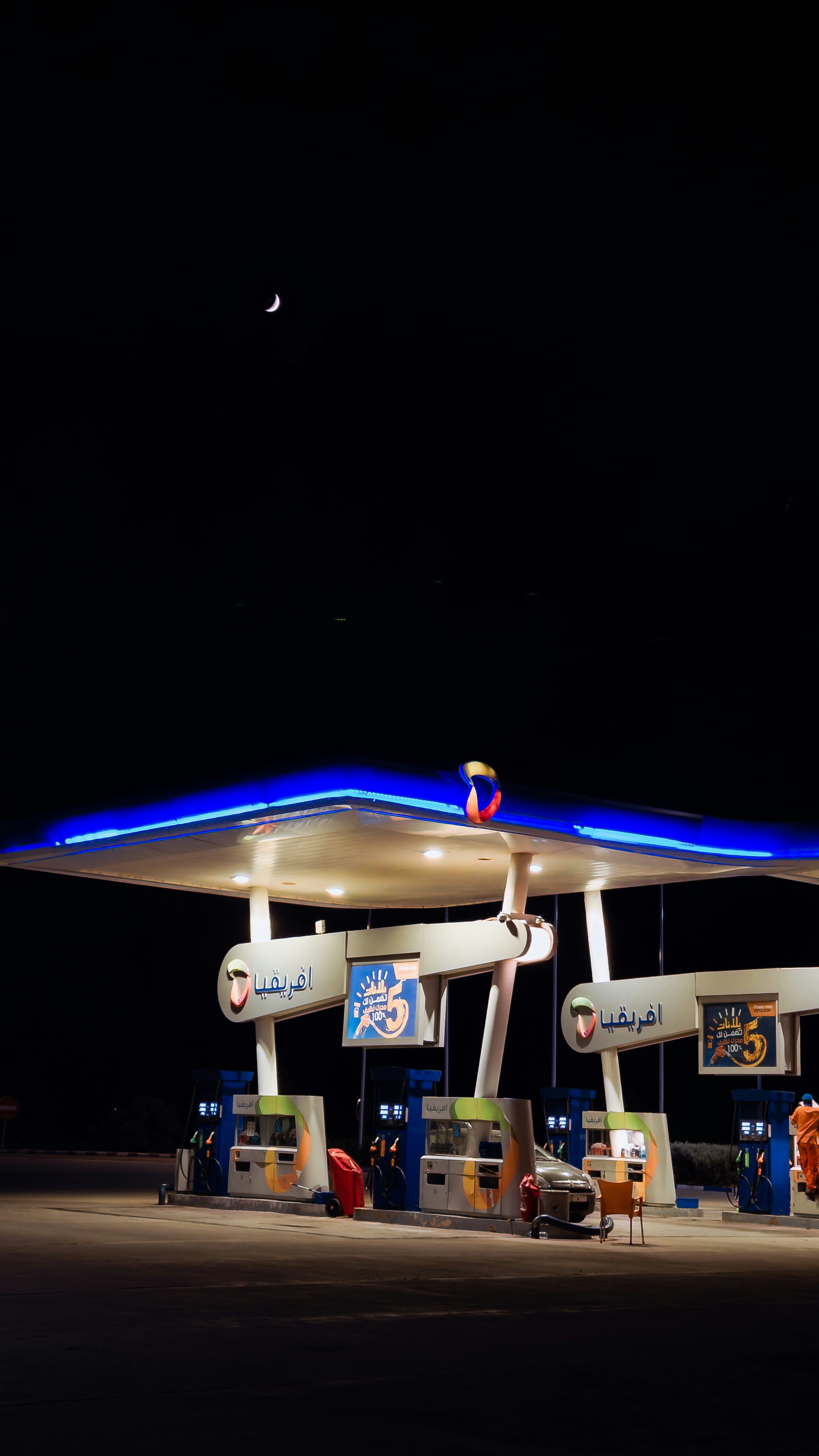 Neon Canopy Over Quiet Fueling Station at Night