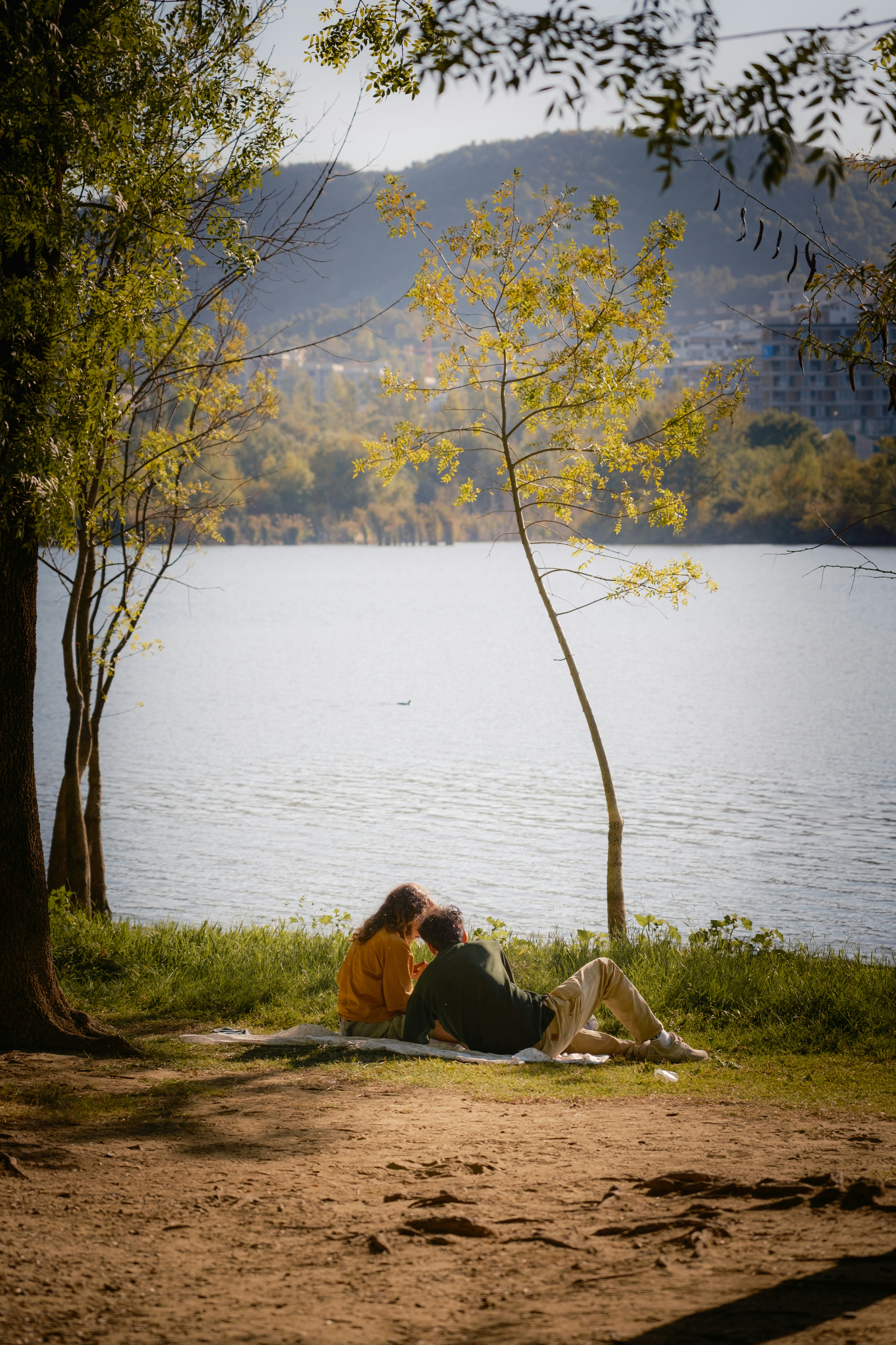 Quiet Riverside Confession: A Couple Resting by the Water