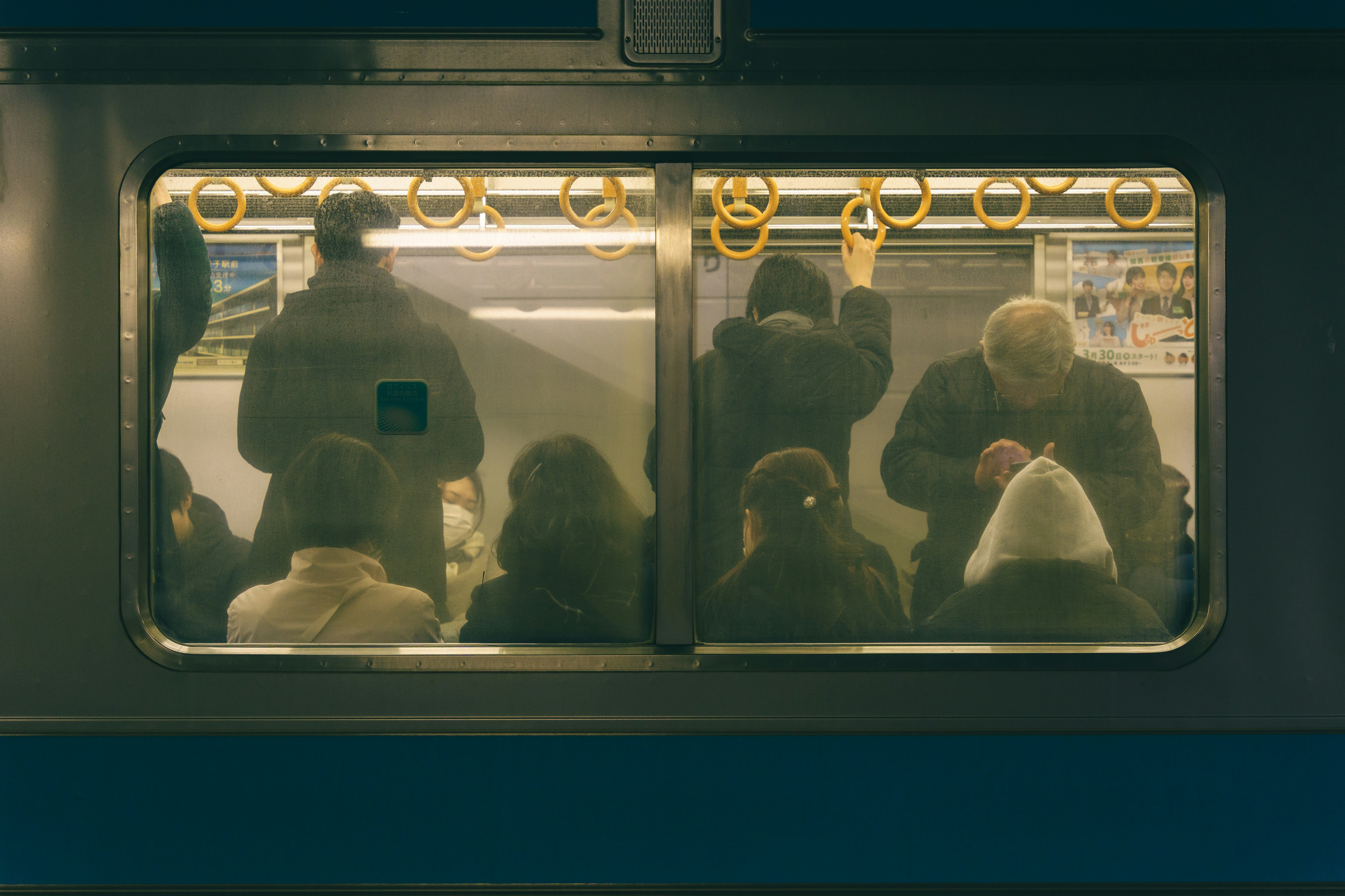 Window Panes and Quiet Commuters: A Subway Car Quietly Observed