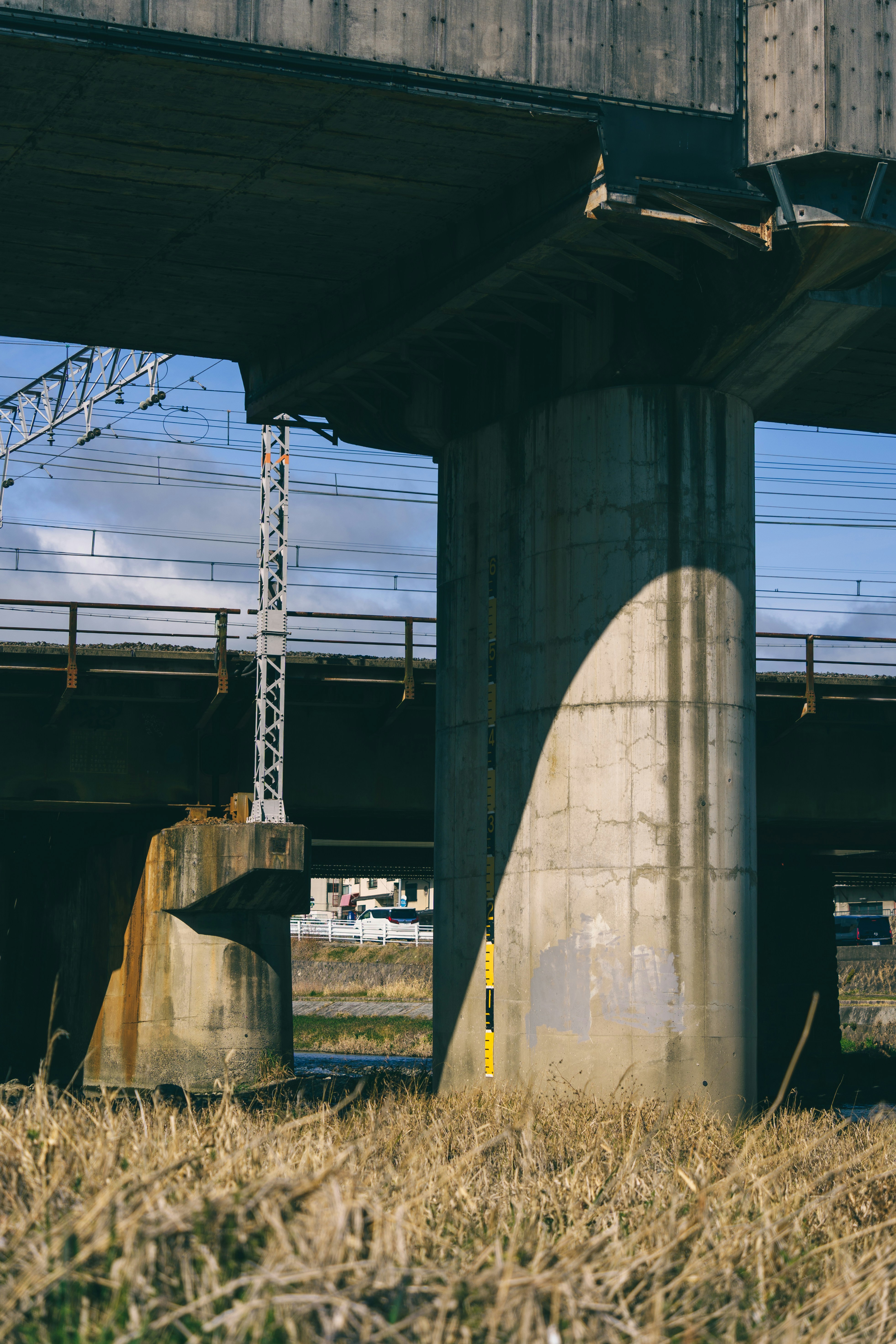 Shadowed Concrete Arches Beneath a Quiet Overpass