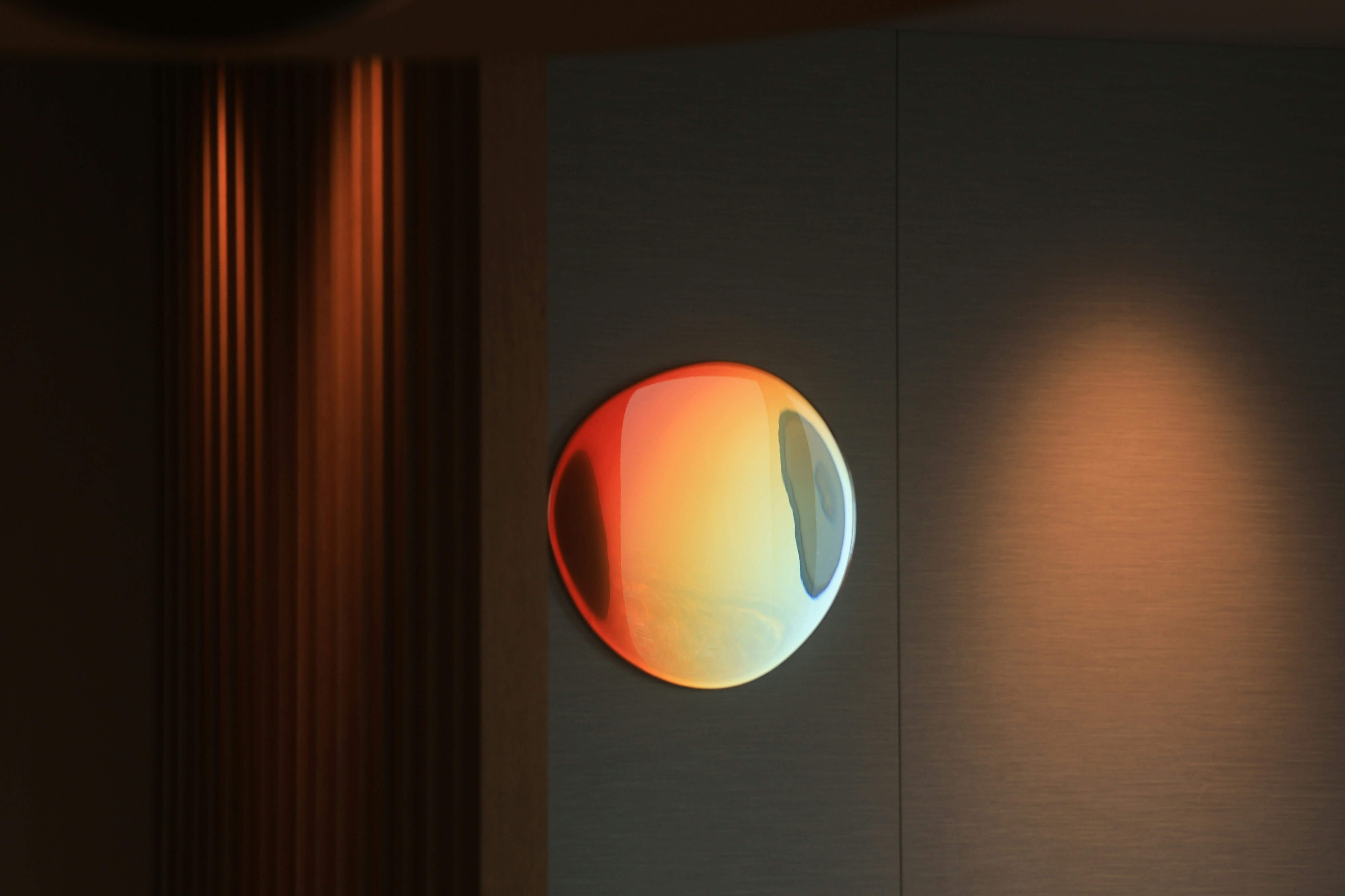 Glow Sphere: A Coral-Blue Echo on a Velvet Wall