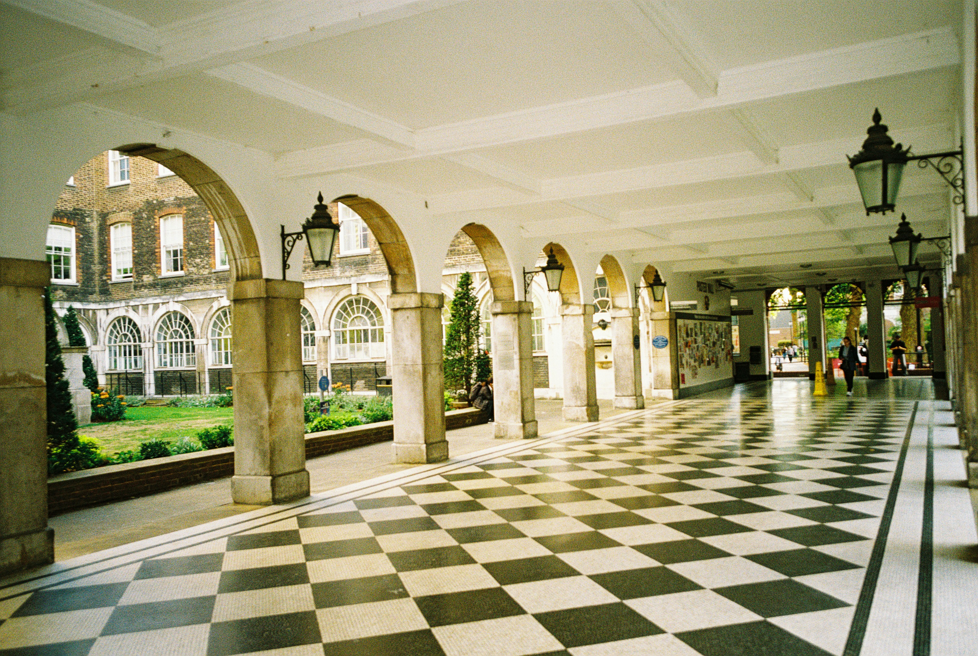 Checkerboard Corridor Under Arched Lanterns