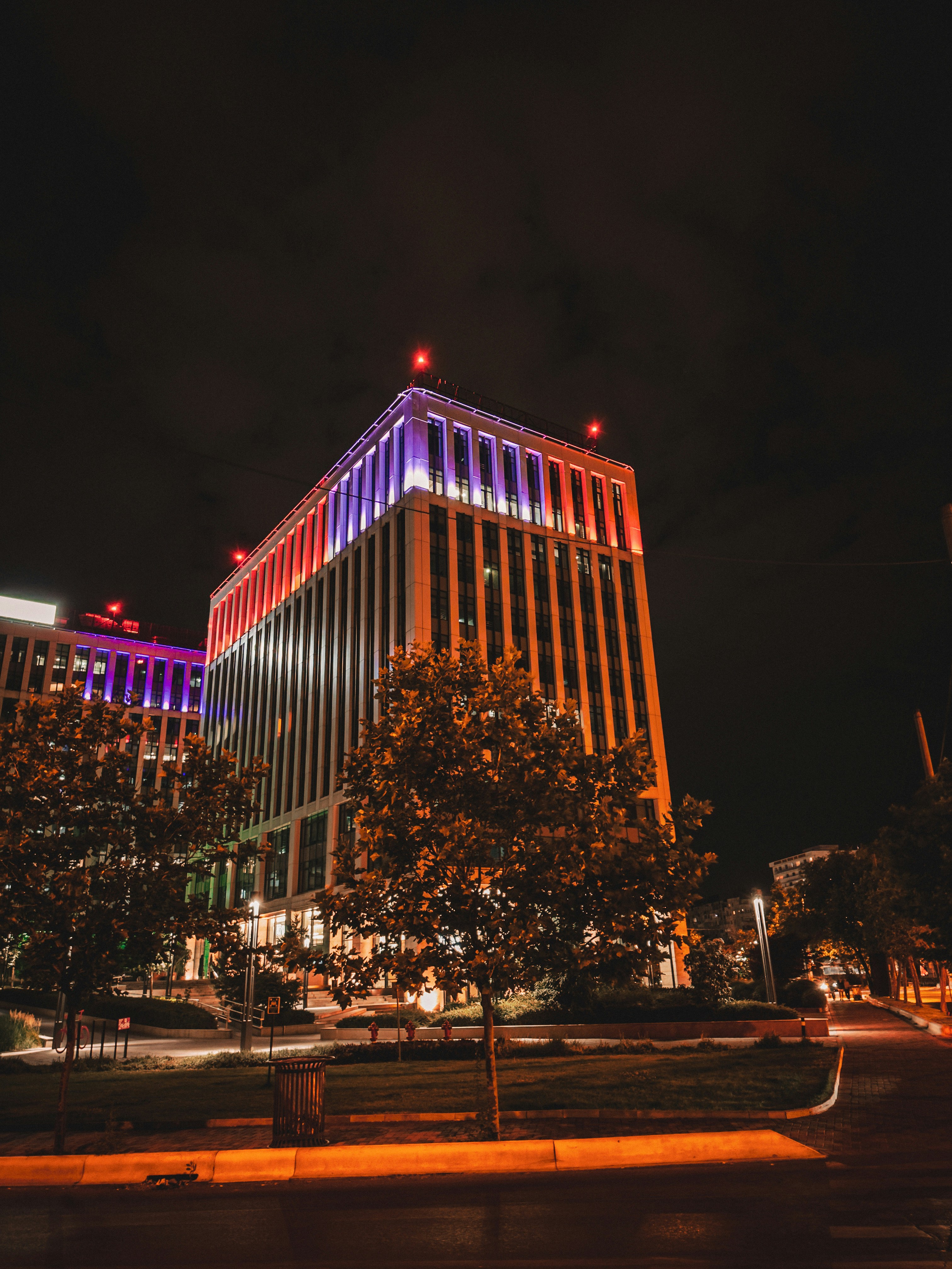 Neon-skirted Highrise: Night-lit Facade with Color-graded Glow